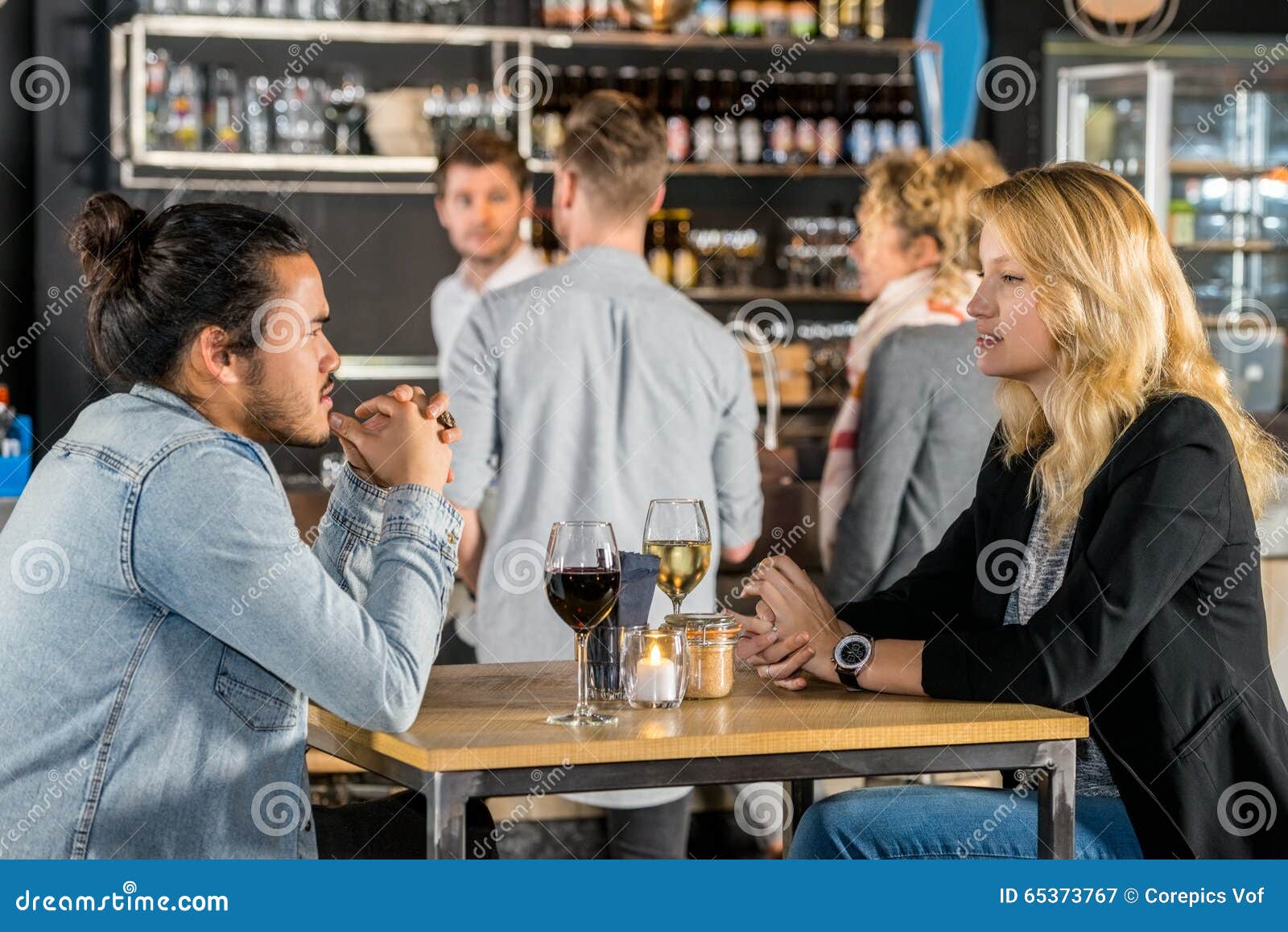 Friends Talking at Table in Bar Stock Image - Image of youth, friend ...