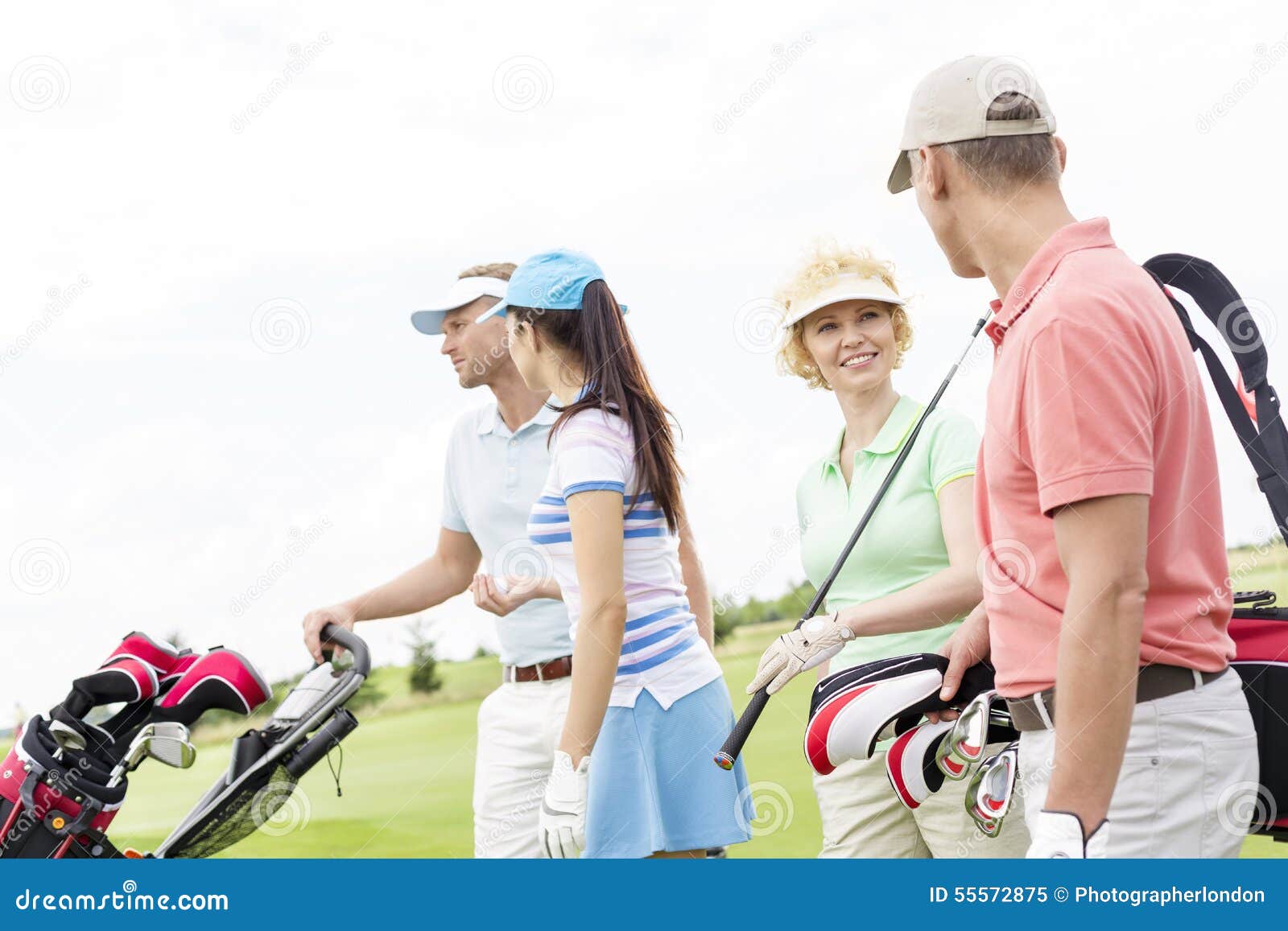 Friends Talking while Walking at Golf Course Against Clear Sky Stock ...