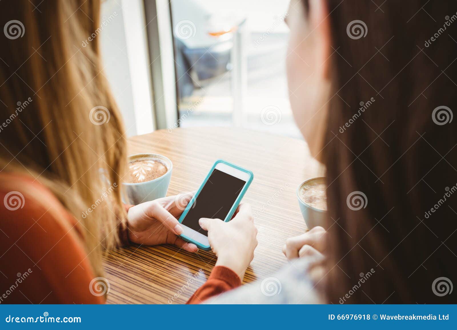 Friends Using Smartphone and Having Coffee Stock Photo - Image of ...