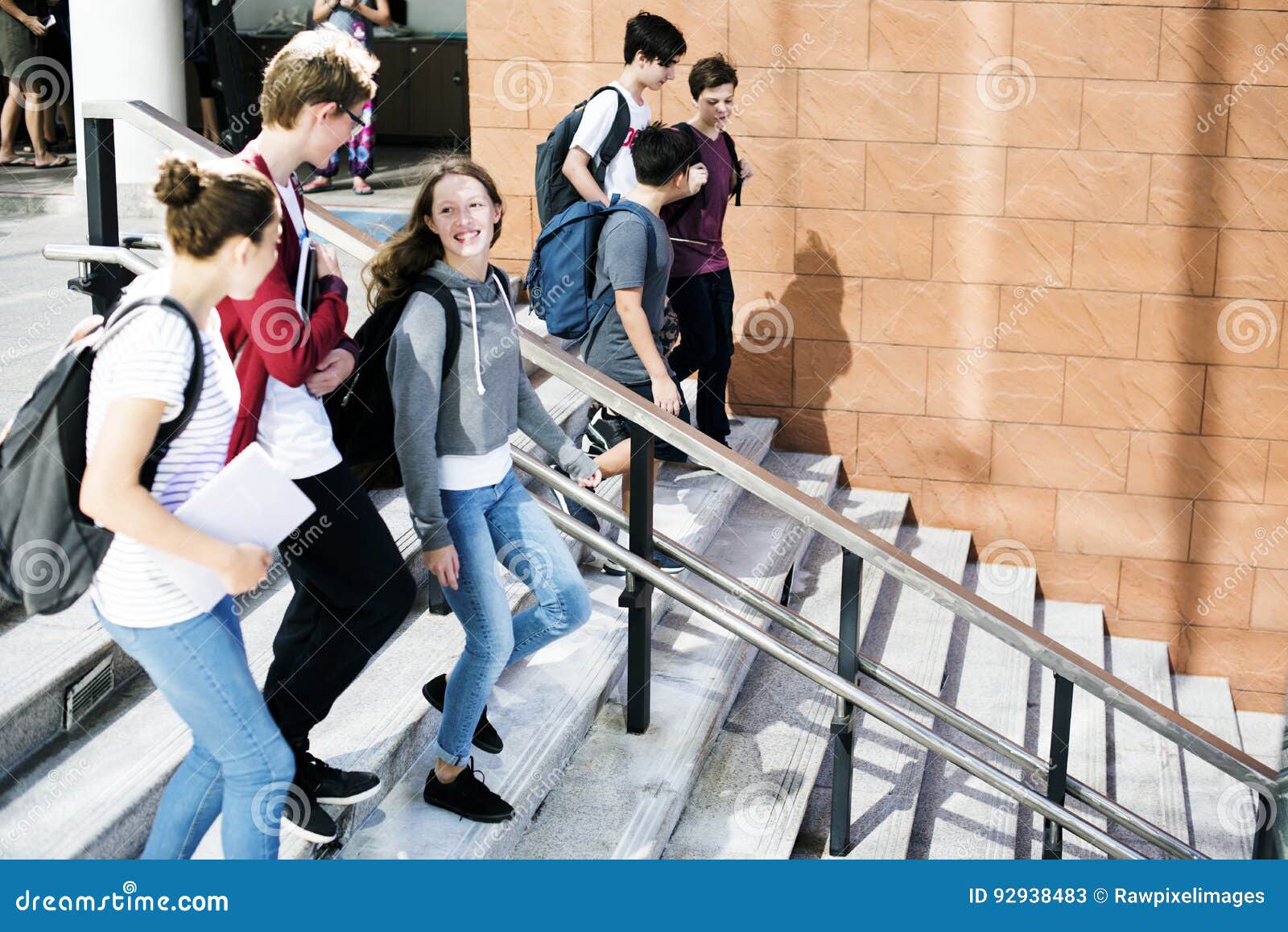 Friends Walking Down Staircase Together Stock Image - Image of candid ...