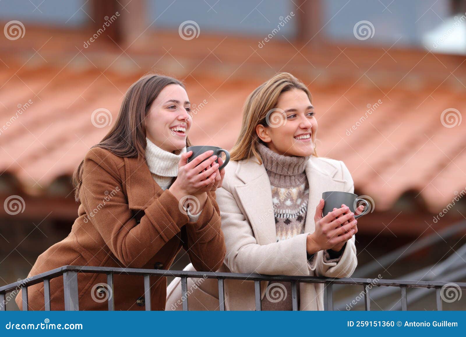 Friends in Winter Talking in a Balcony with Coffee Cups Stock Photo ...