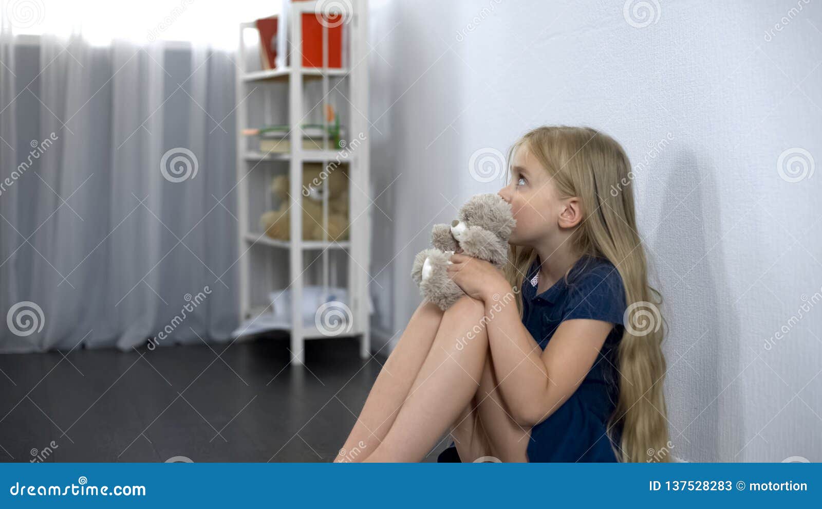 Frightened Girl with Toy Friend Sitting on Floor, Scared of Imaginary ... Frightened Girl with Toy Friend Sitting on Floor, Scared of Imaginary ...