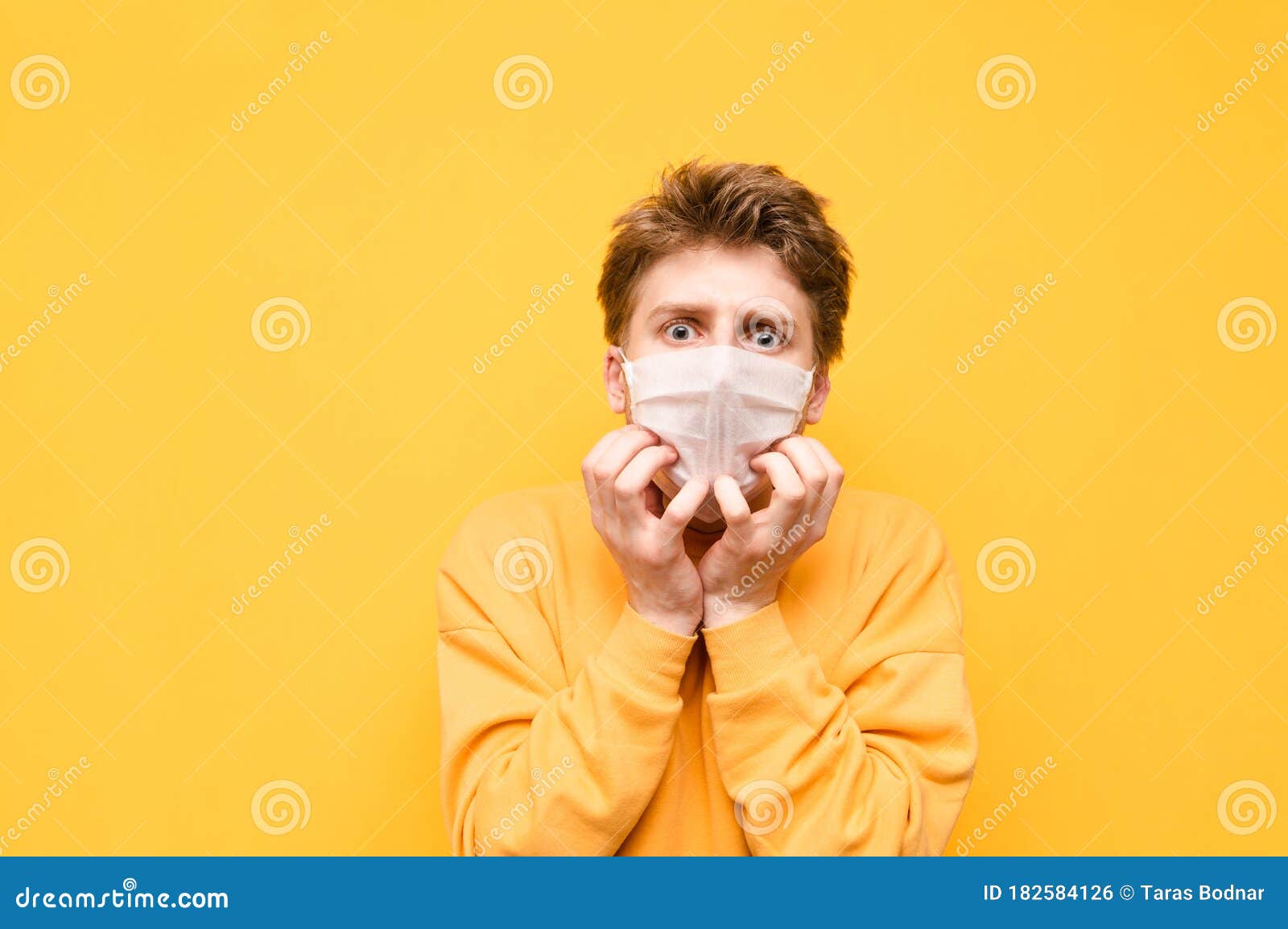 A Frightened Guy in a Protective Mask is Isolated on a Yellow ...