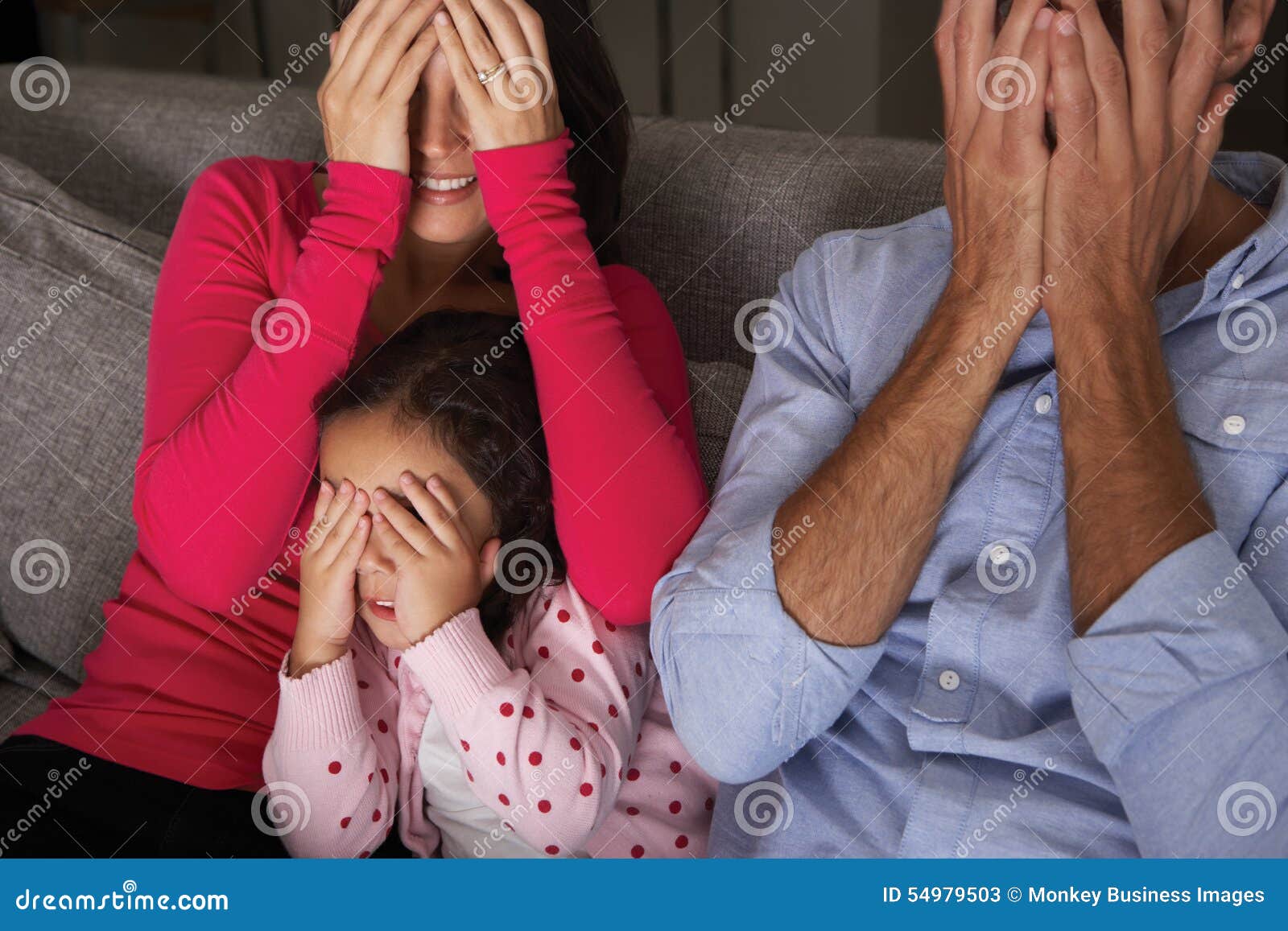 Frightened Hispanic Family Sitting on Sofa and Watching TV Stock Image ...