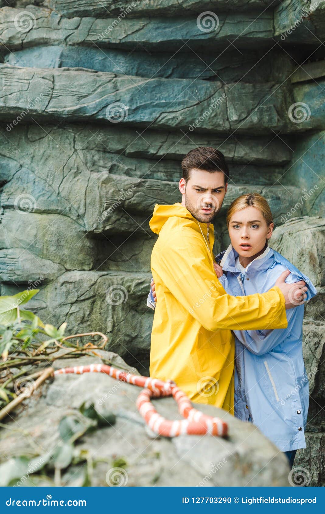 Frightened Young Couple in Raincoats Terrified Stock Photo - Image of ...