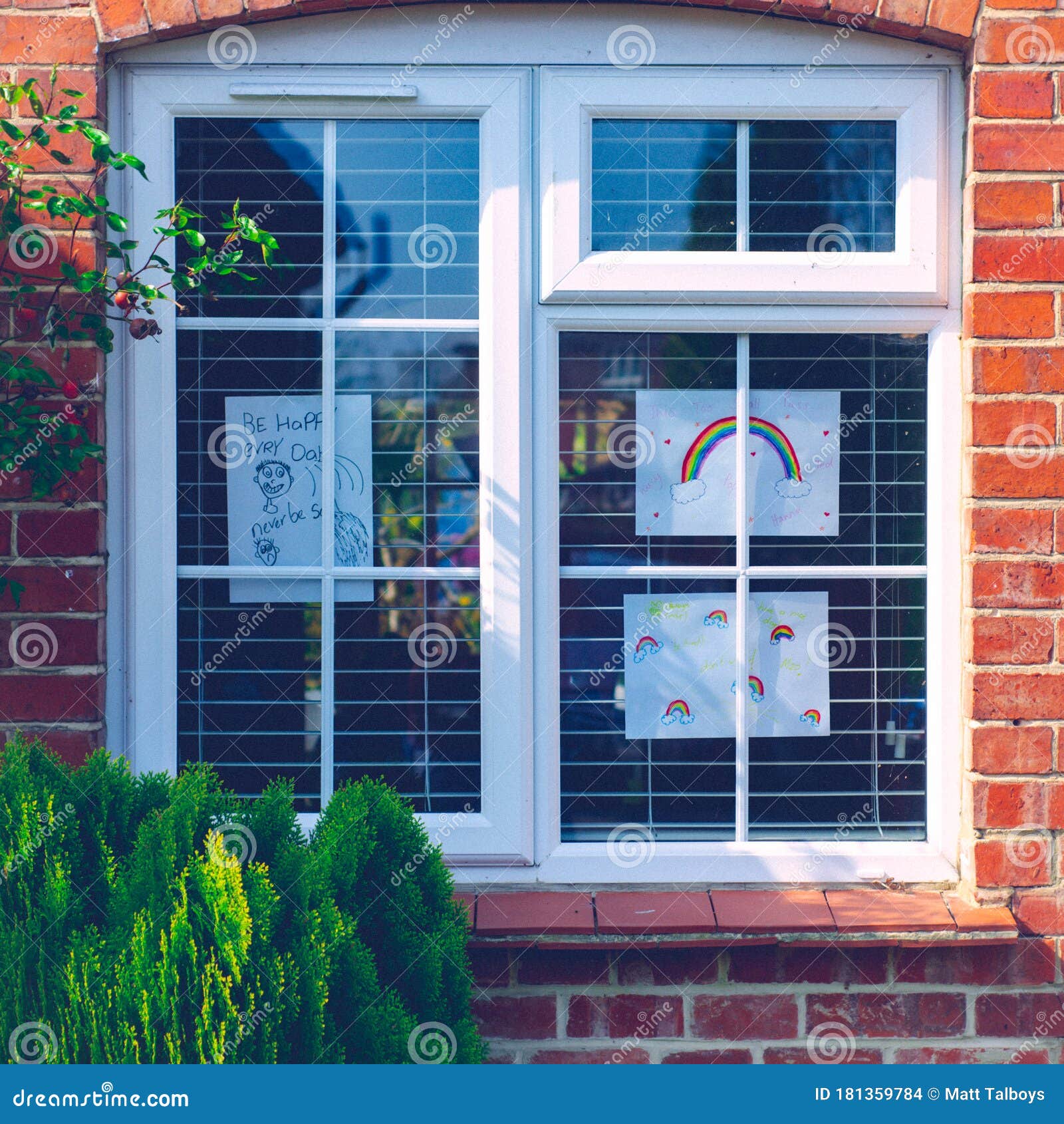The Front of a Brick Building Showing Messages of Stay Home and Save ...