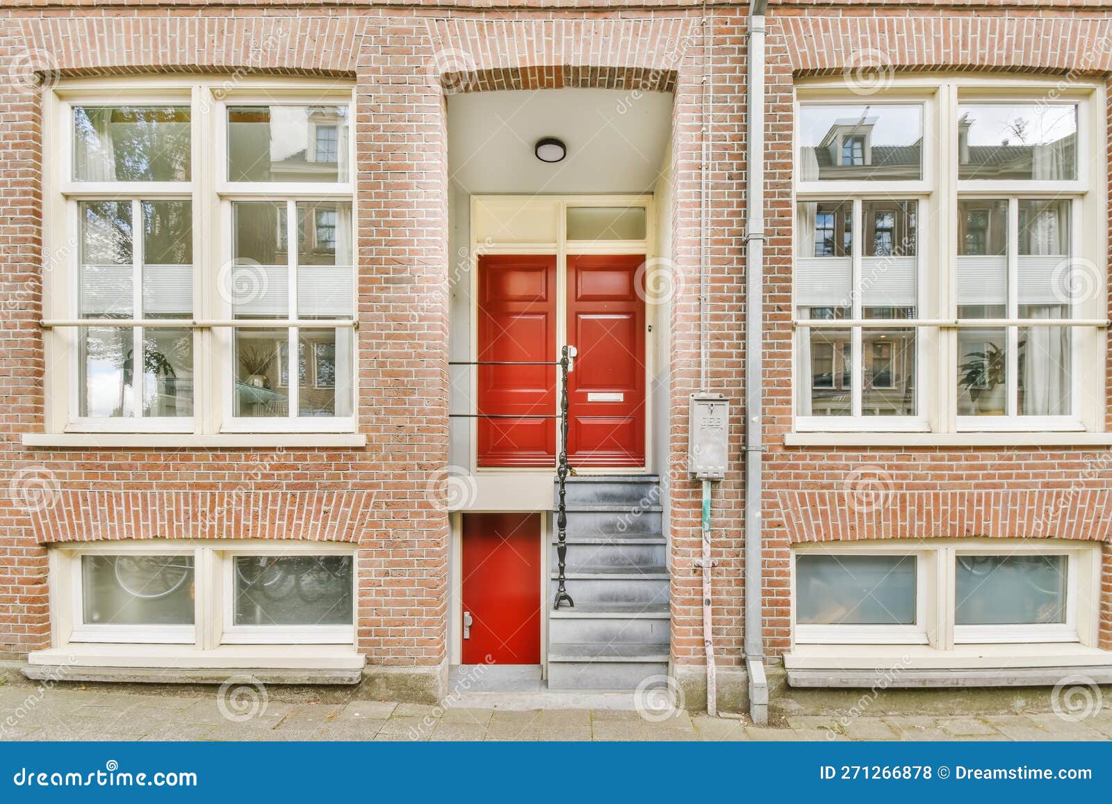 The Front of a Brick House with a Red Door Stock Photo - Image of ...