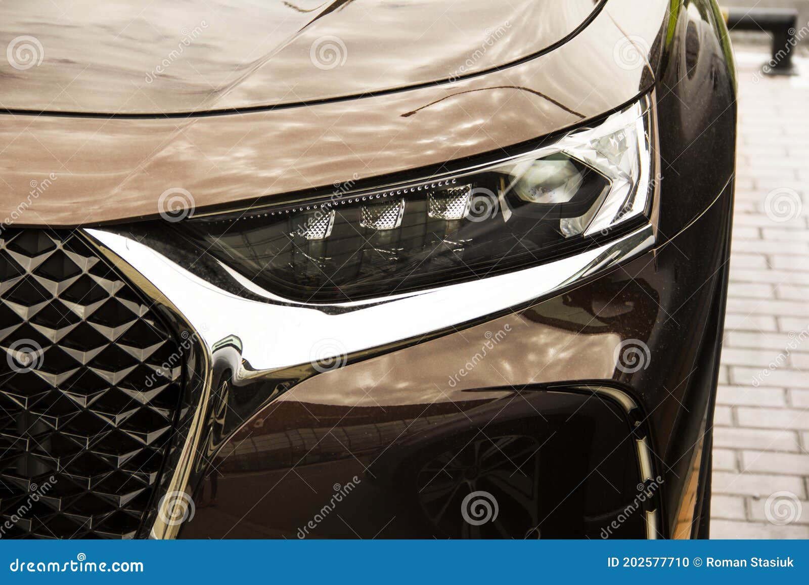 The Front of a Brown Car. Car Headlights Stock Photo - Image of glass ...