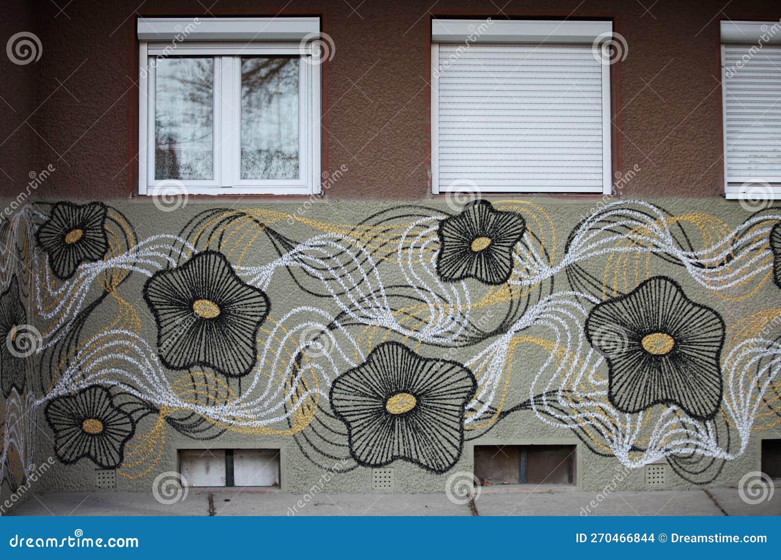 The Front of the Building with White Windows and Graffiti on the Lower ...