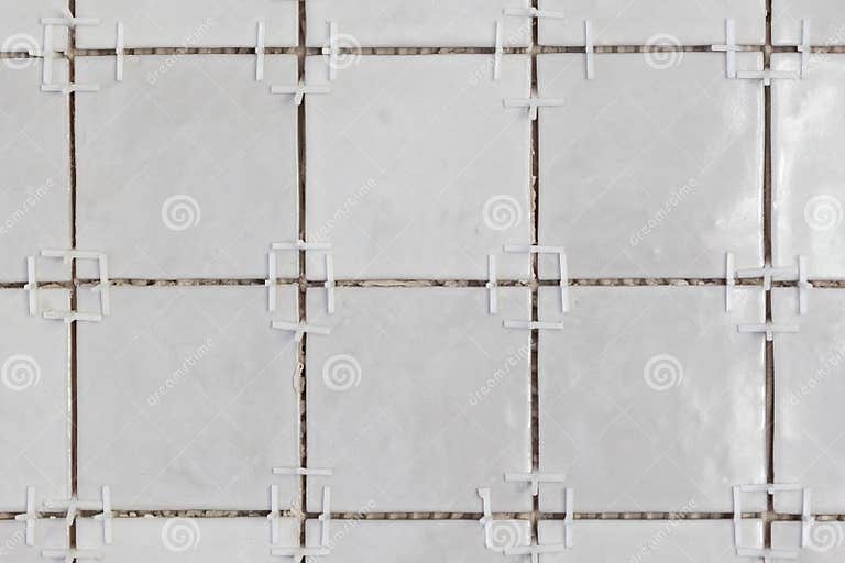 A Front Close Up of a Tile Wall Under Construction. the Wall is Being ...