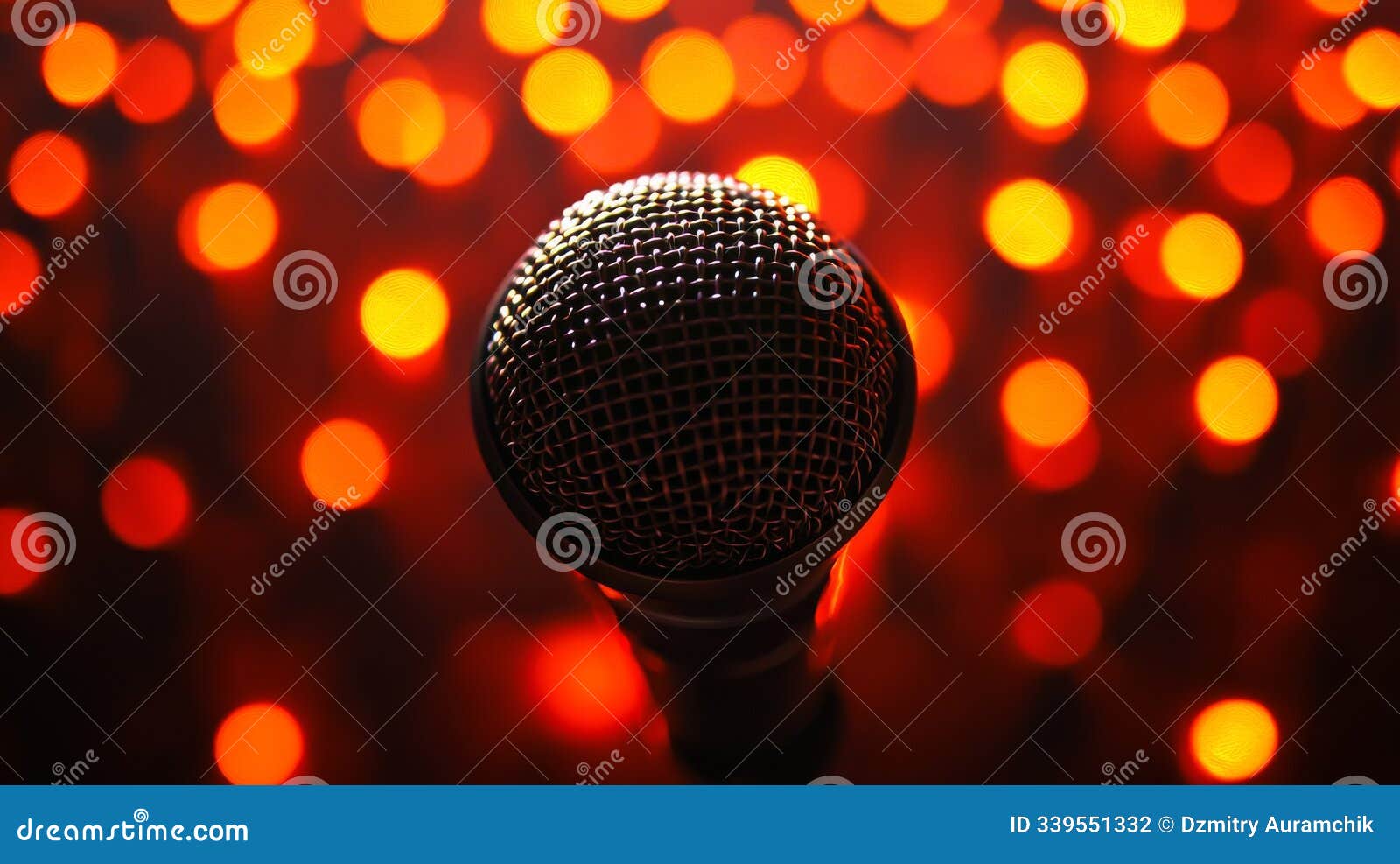 In Front of Dim Stage Lights and a Blurred Crowd, a Microphone Sits on ...