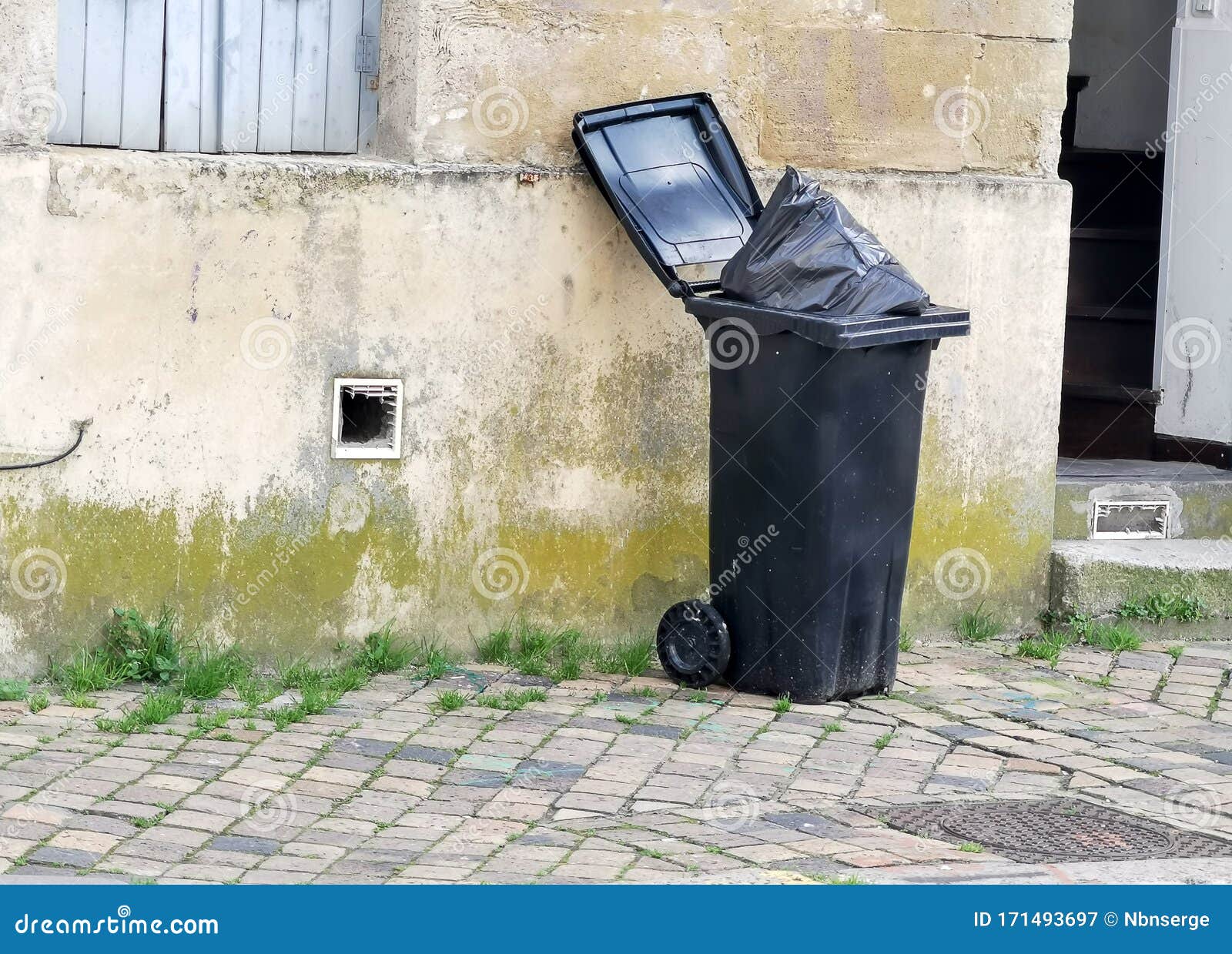Front Door Open and Dark Grey Waste Bin Filled with Garbage and Plastic ...