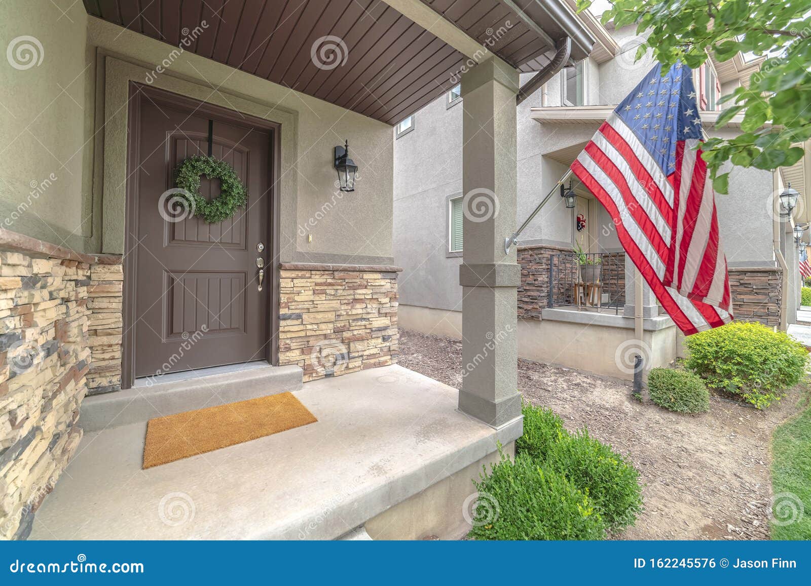 Front Door of Suburban Home with American Flag Stock Photo - Image of ...