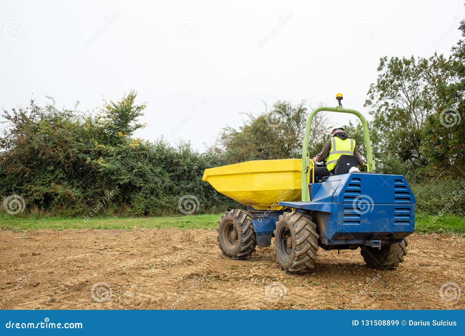 Front Dumper Being Operated by a Construction Worker. Stock Image ...