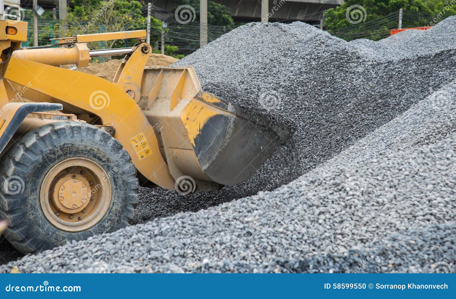 Front End Loader Dumping Stone in a Mining Quarry Stock Photo - Image ...
