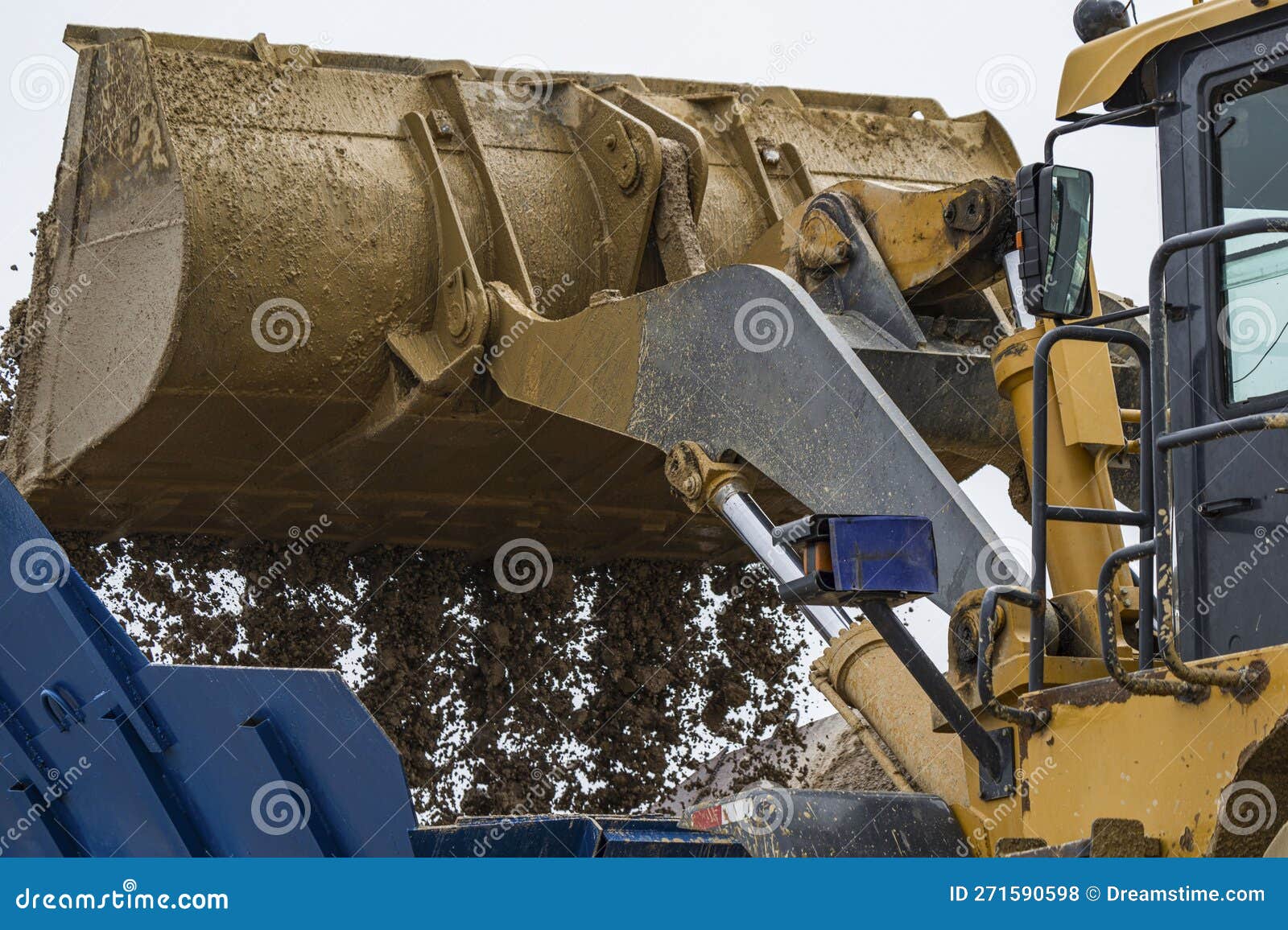 Front End Loader Dumping Stone and Sand in a Stock Photo - Image of ...