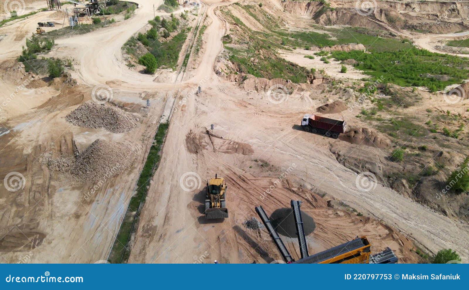 Front End Loader Loading Gravel into Jaw Crusher in Open-pit. Arial ...