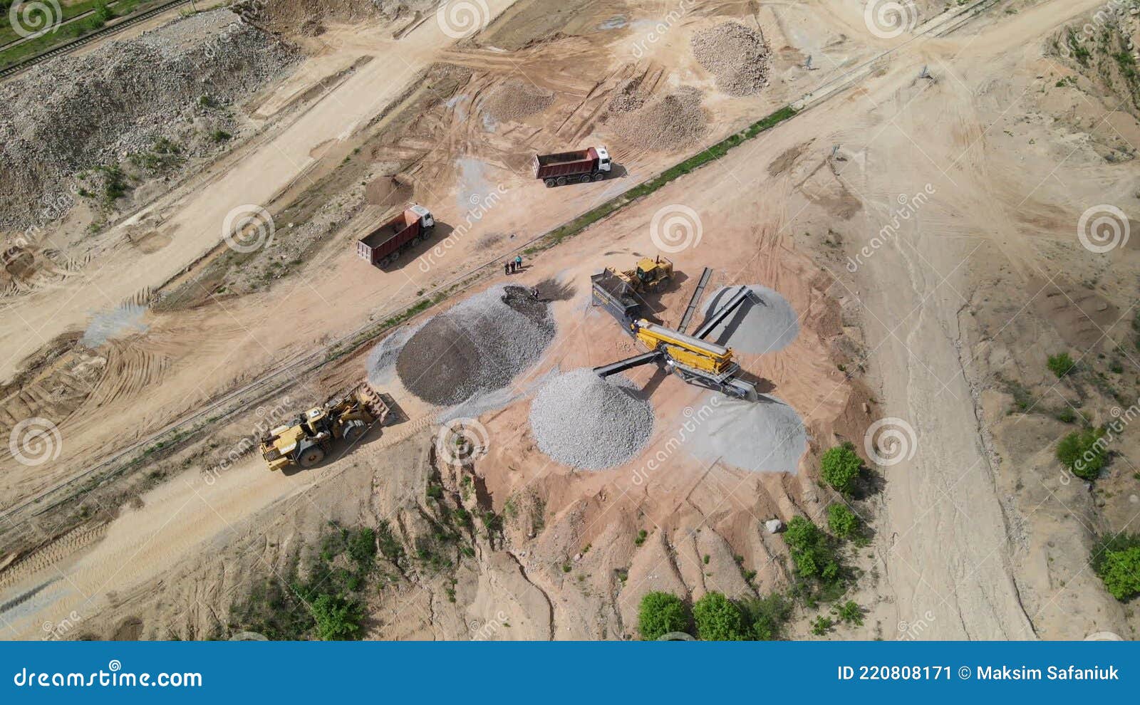 Front End Loader Loading Gravel into Jaw Crusher in Open-pit. Arial ...