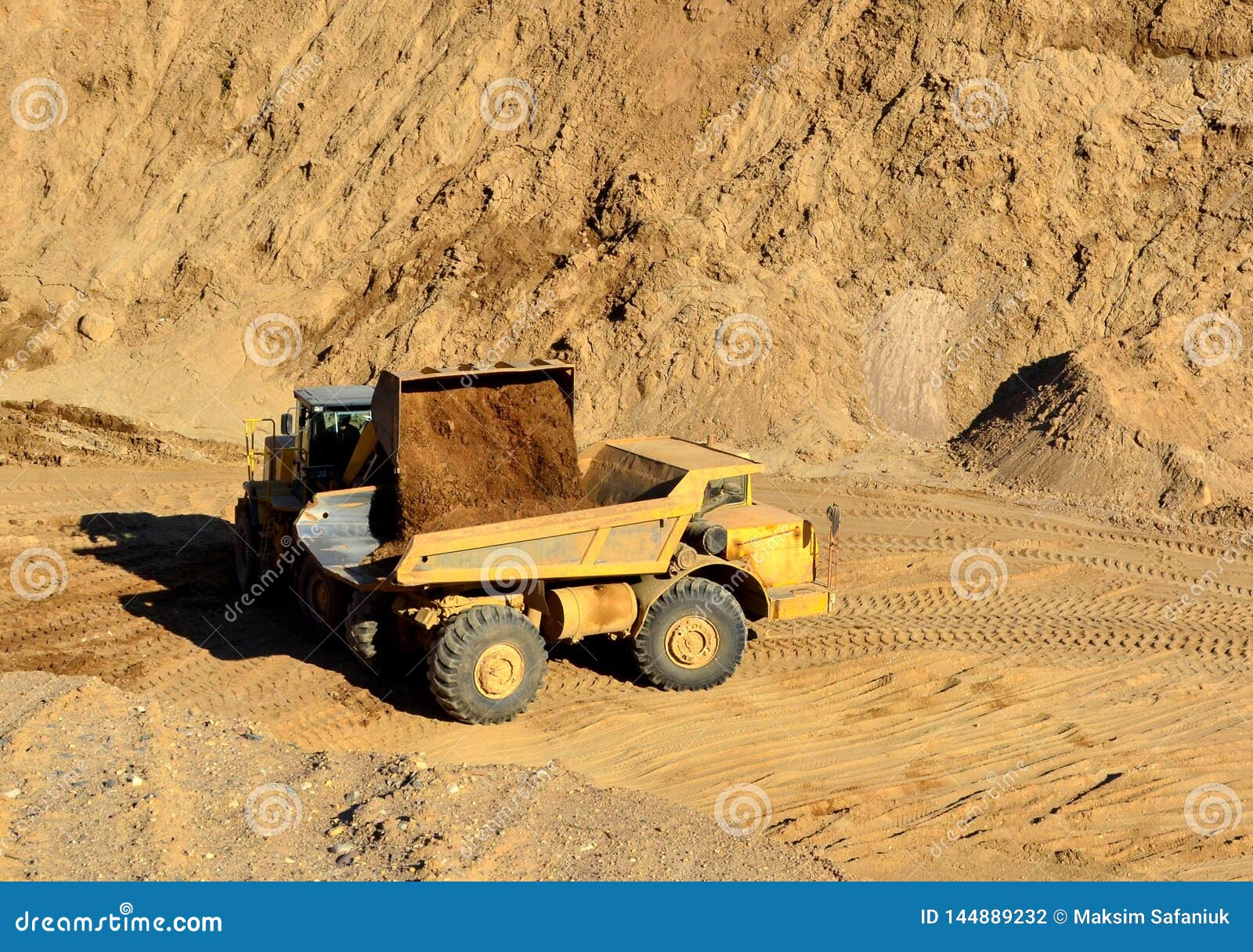 Front-end Loader Loading with Sand a Heavy Dump Truck Stock Photo ...