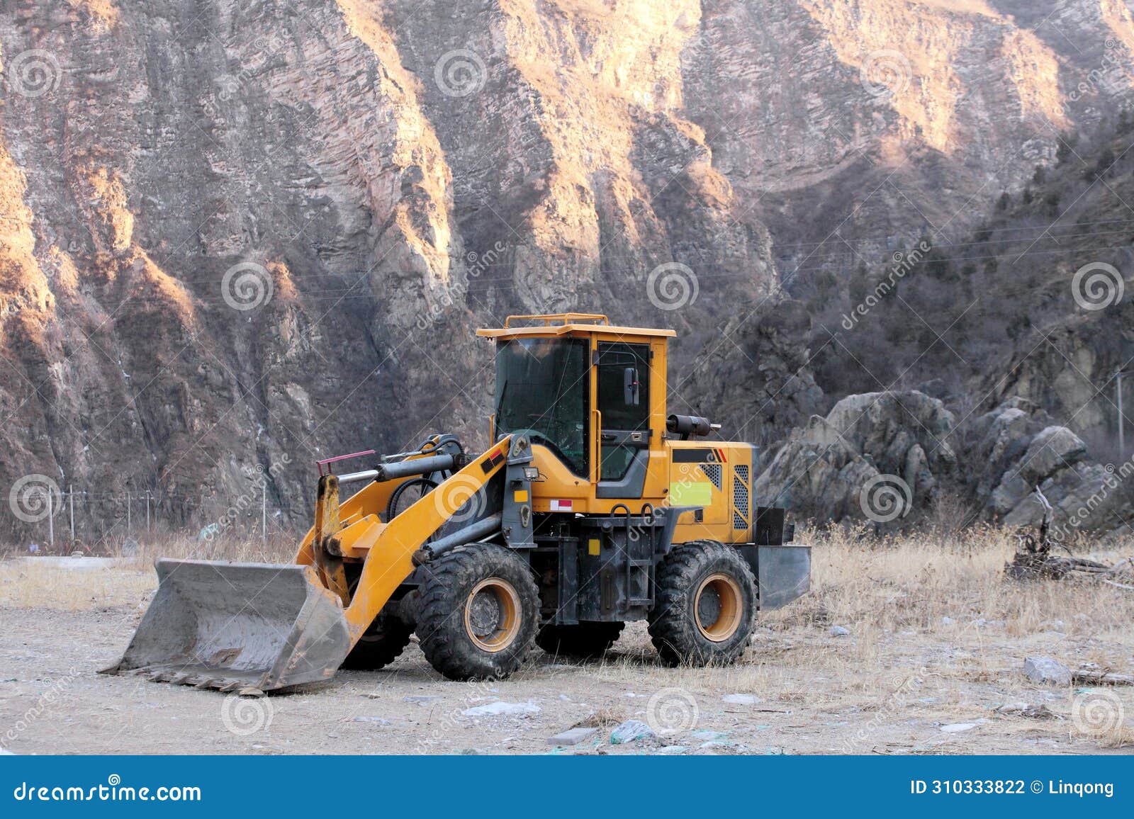 Front End Loader Parked in a Clearing in the Mountains. Stock Photo ...