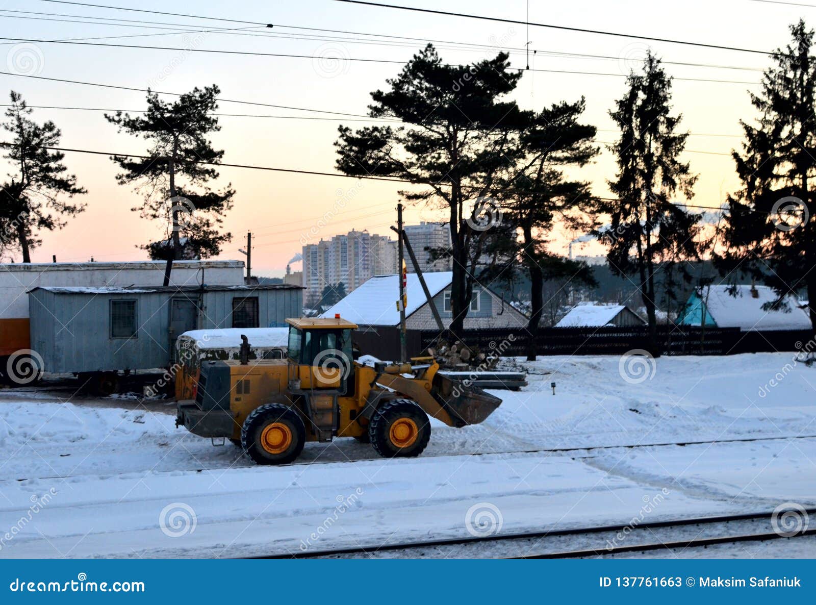 Front-end Loader with Wheels on a Construction Site in Winter Against ...