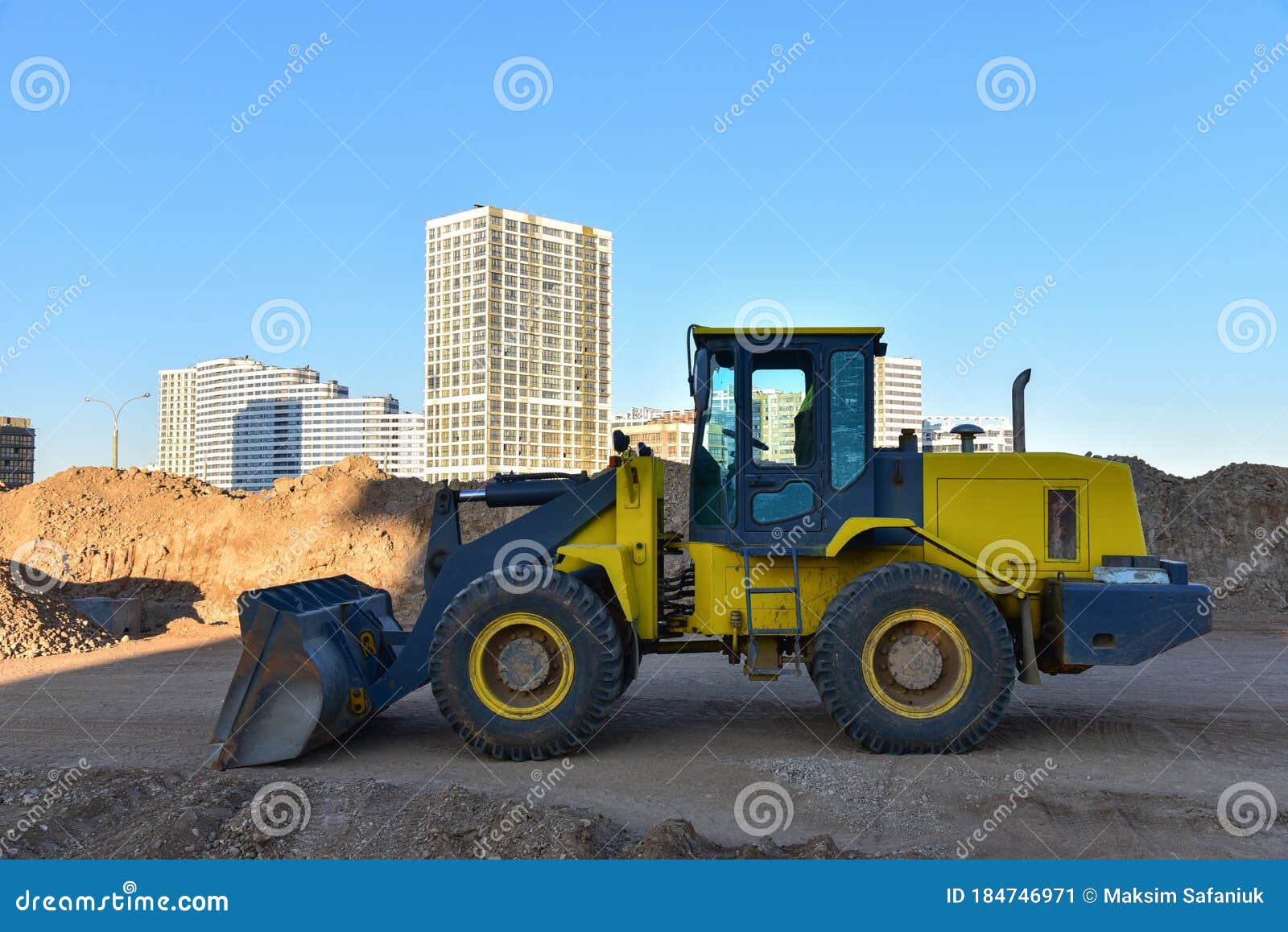 Front-end Loader Working at Construction Site. Earth-moving Heavy ...