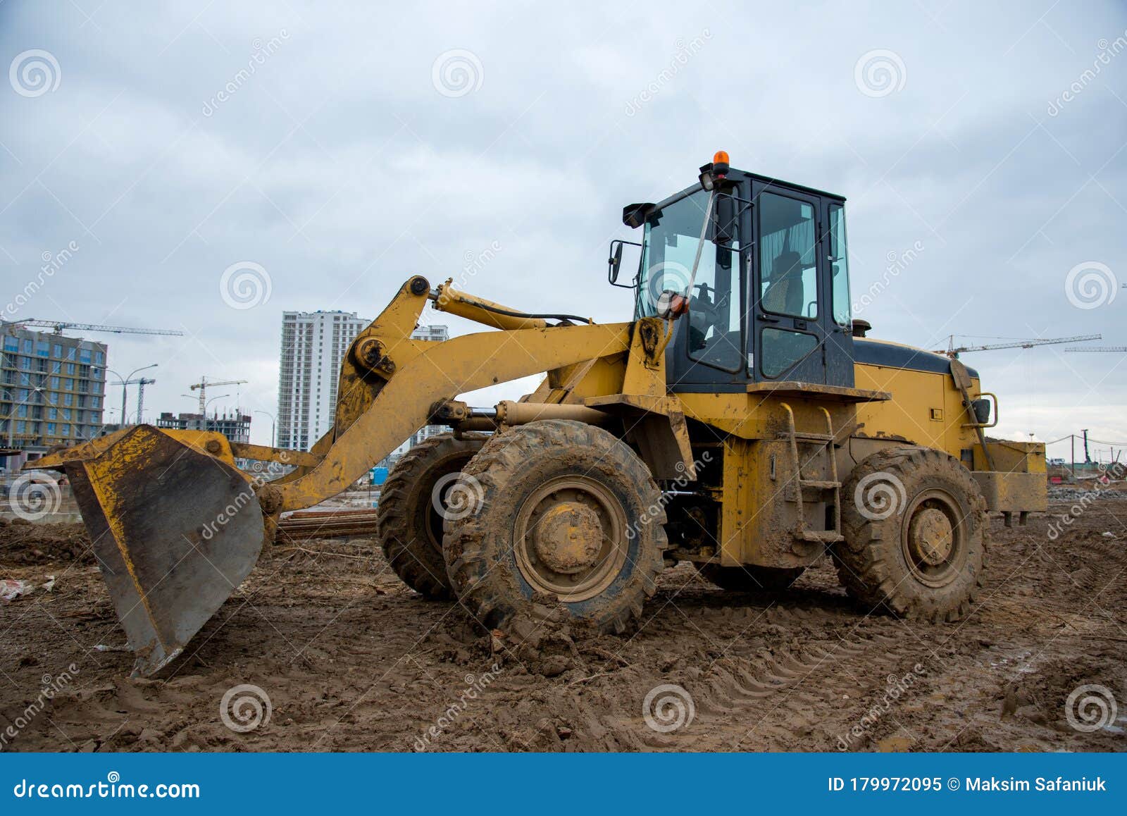 Front-end Loader Working at Construction Site. Earth-moving Heavy ...