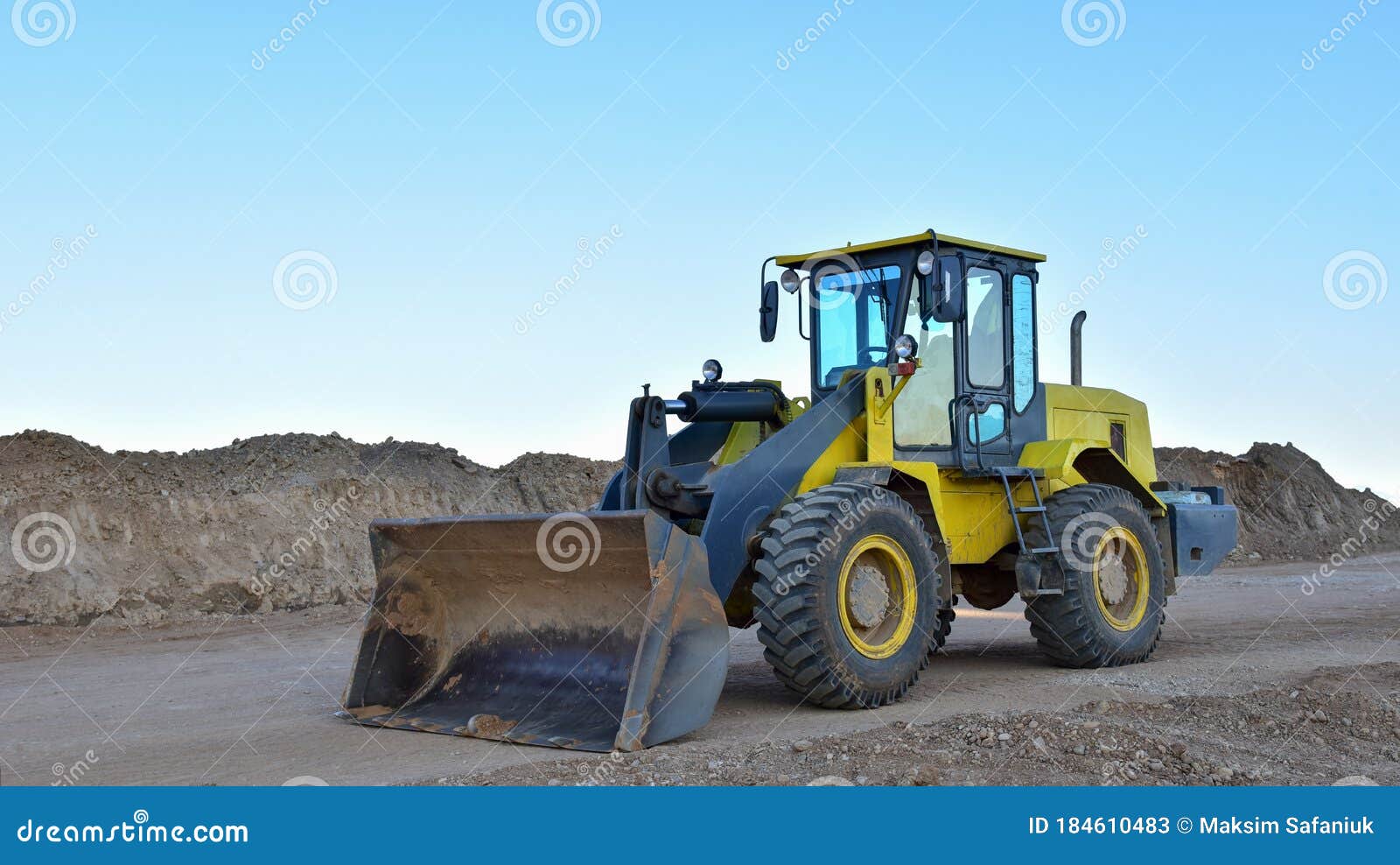 Front-end Loader Working at Construction Site. Earth-moving Heavy ...