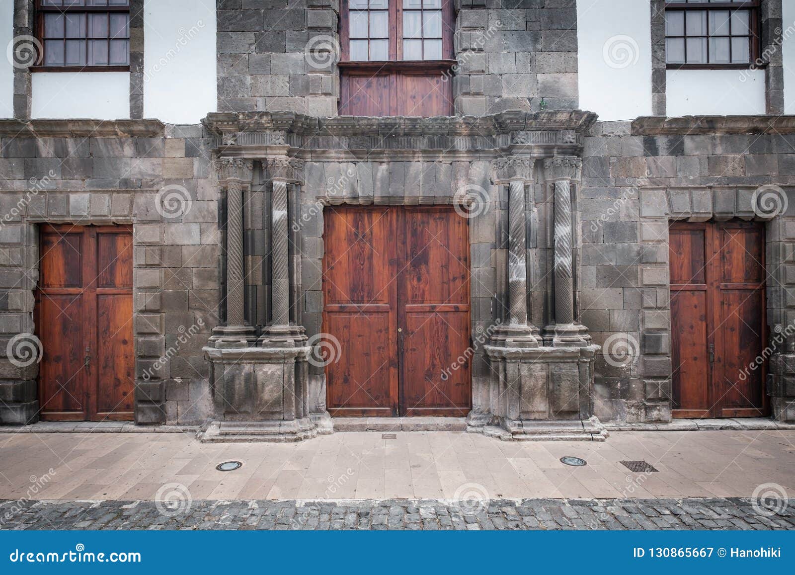 Front of Historic Building Facade with Wooden Doors Stock Image - Image ...
