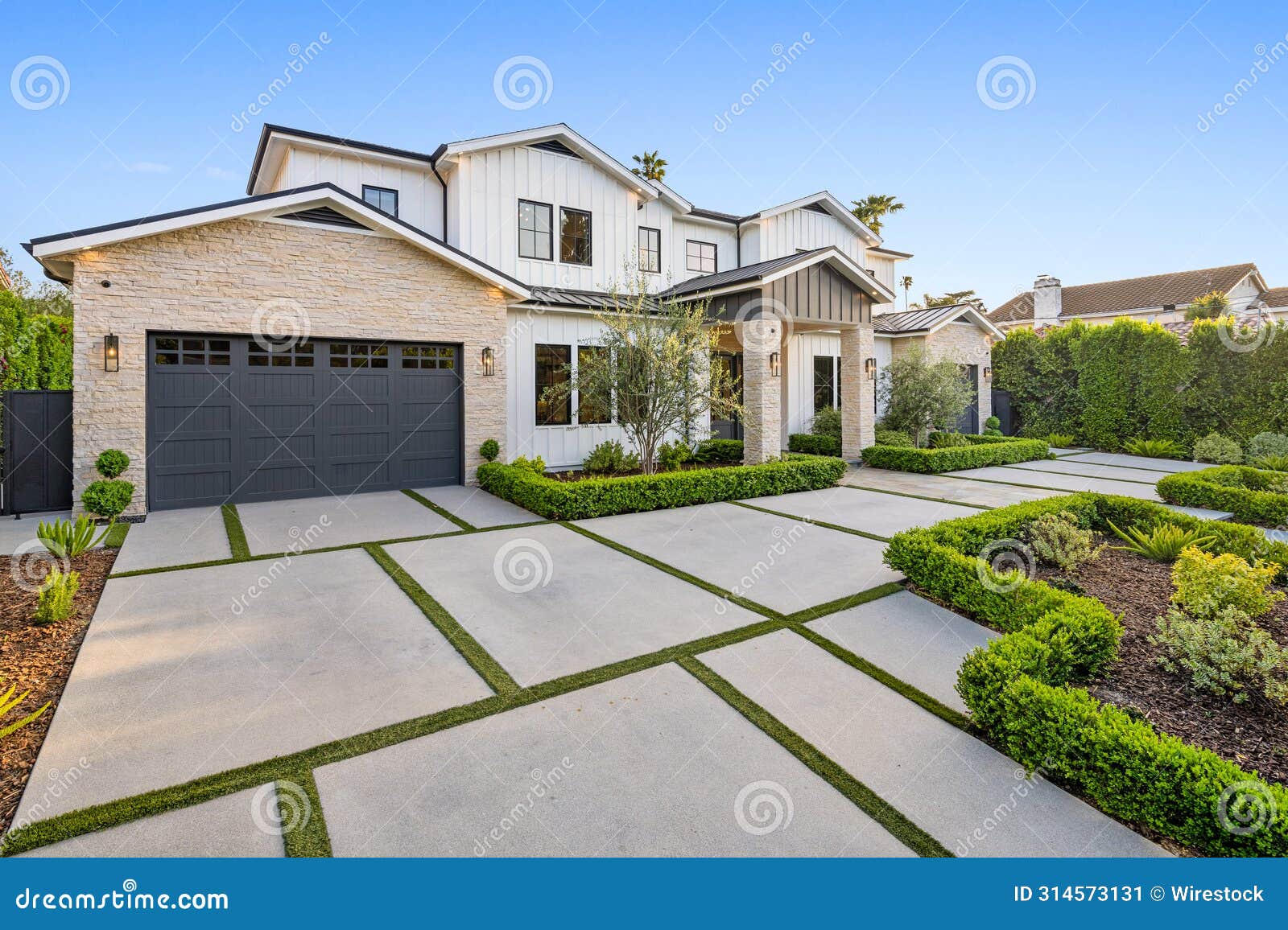 The Front of this Home is Well Maintained and Has a Garage with Doors ...