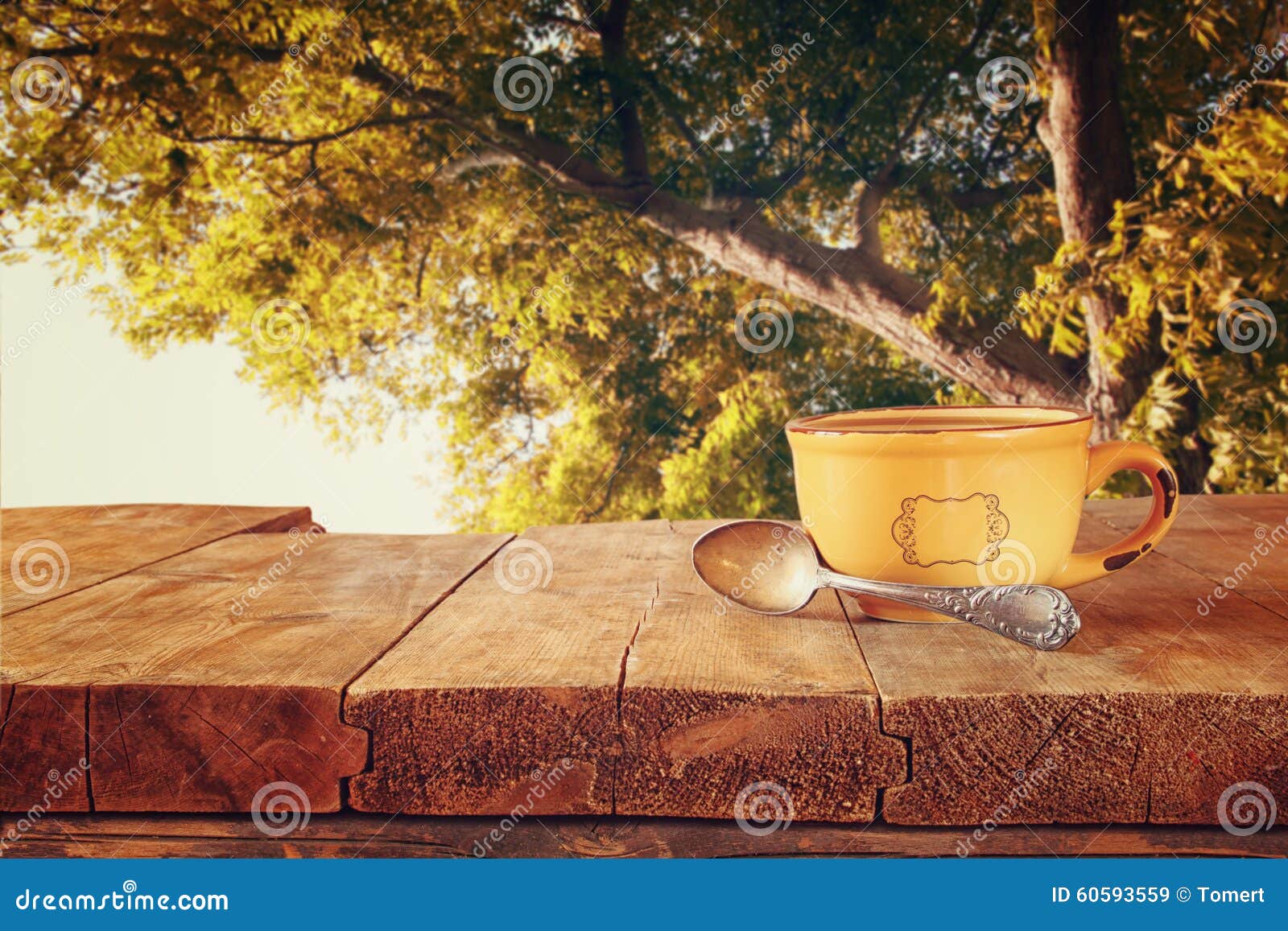 Front Image of Coffee Cup Over Wooden Table and Autumn Leaves in Front ...