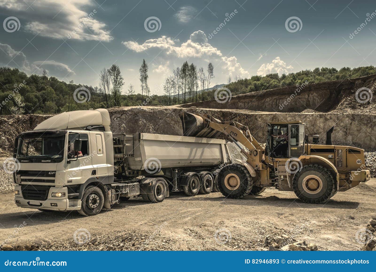 Front Load Loader Beside White Dump Truck Picture. Image: 82946893