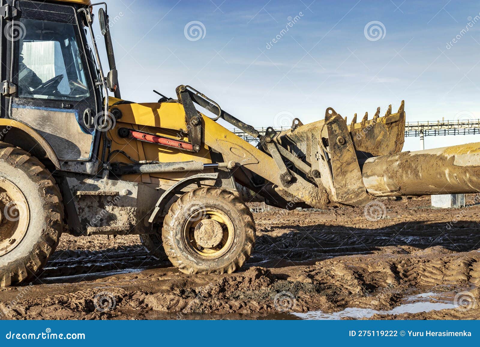 A Front Loader or Bulldozer Transports a Large Pipe To a Construction ...