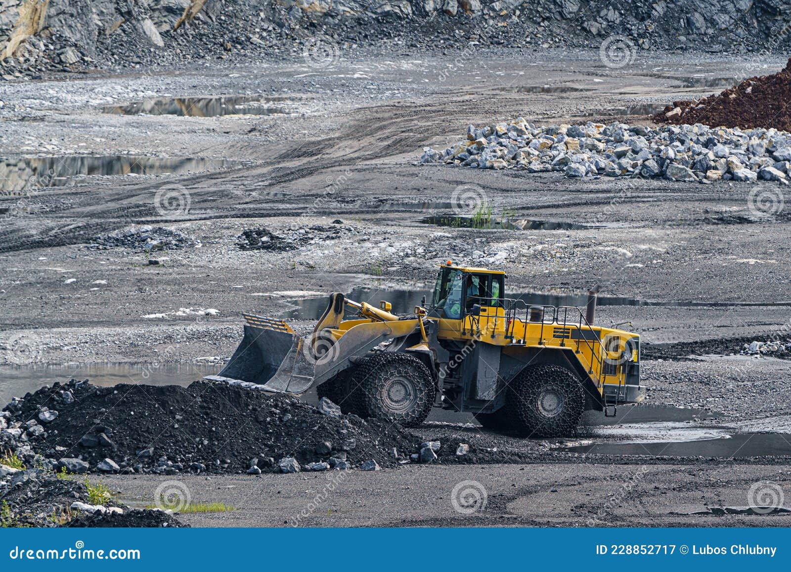 Front Loader with Large Wheels and Steel Chains. Opencast Mining Quarry ...