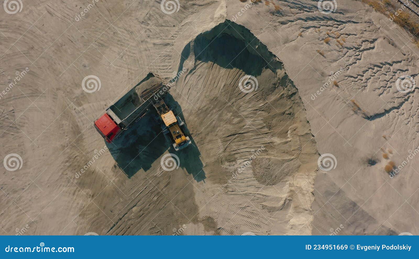 Front Loader Loading Crushed Stone into Dump Truck in Quarry, Aerial ...