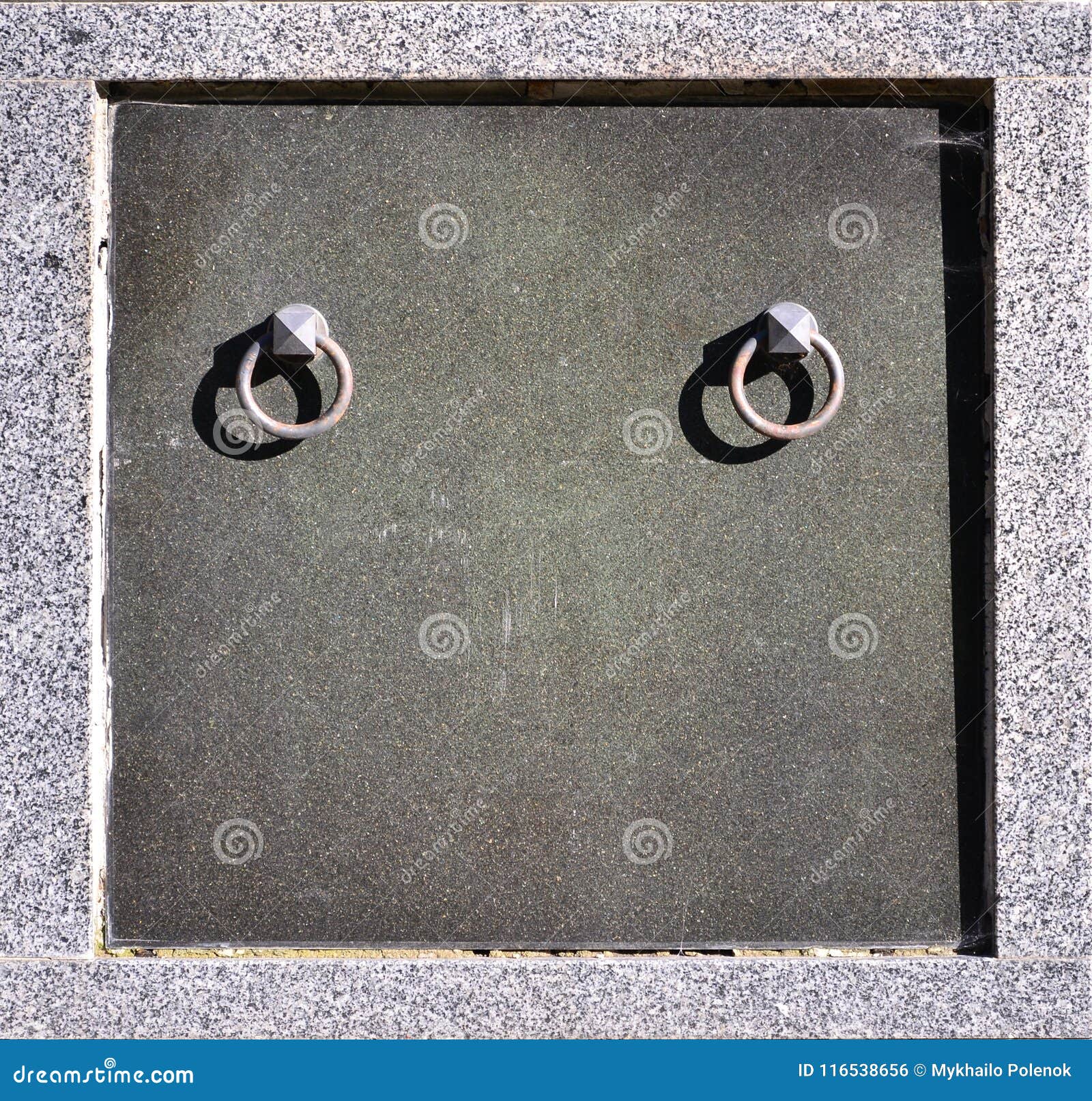 The Front Part of the Granite Crypt with Metal Ring Handles in the ...