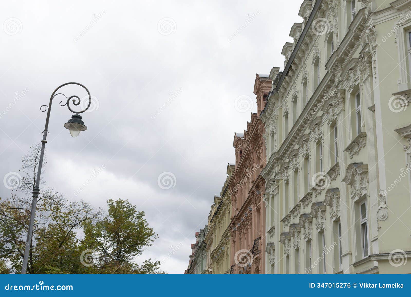 In Front of a Row of Buildings, a Street Light is Positioned Stock ...