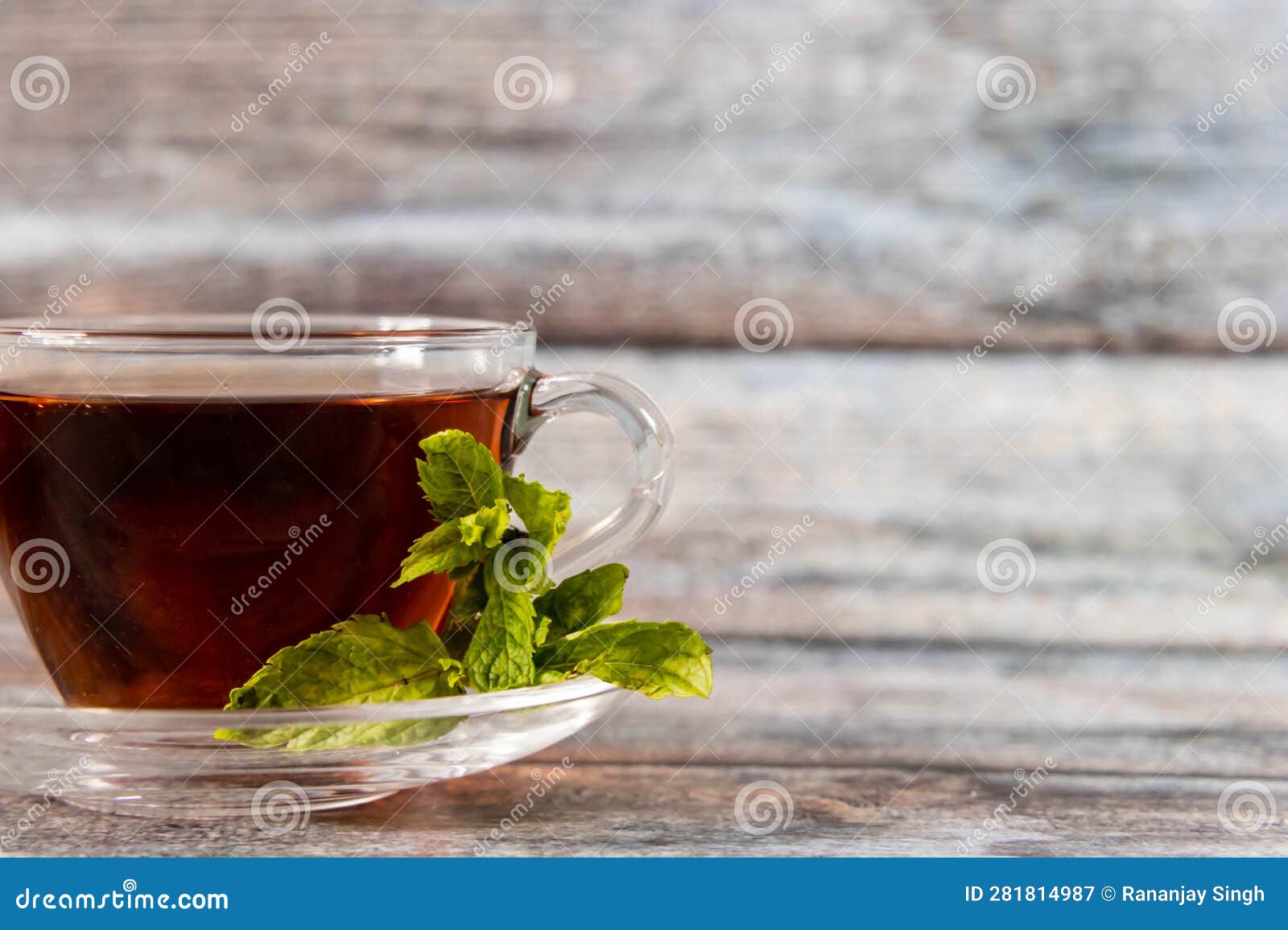 Front Shot of Black Tea and Mint Leaves with Defocused Background and ...