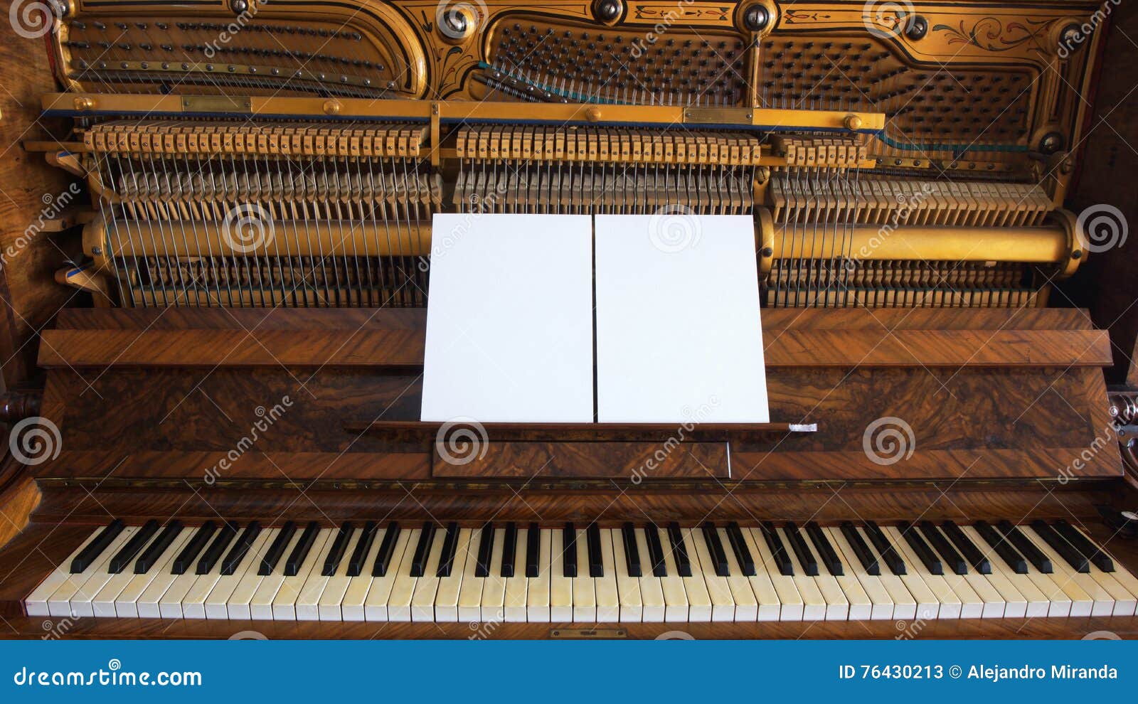 Front View of an Antique Piano with the Keyboard Open and Two Sheets of ...