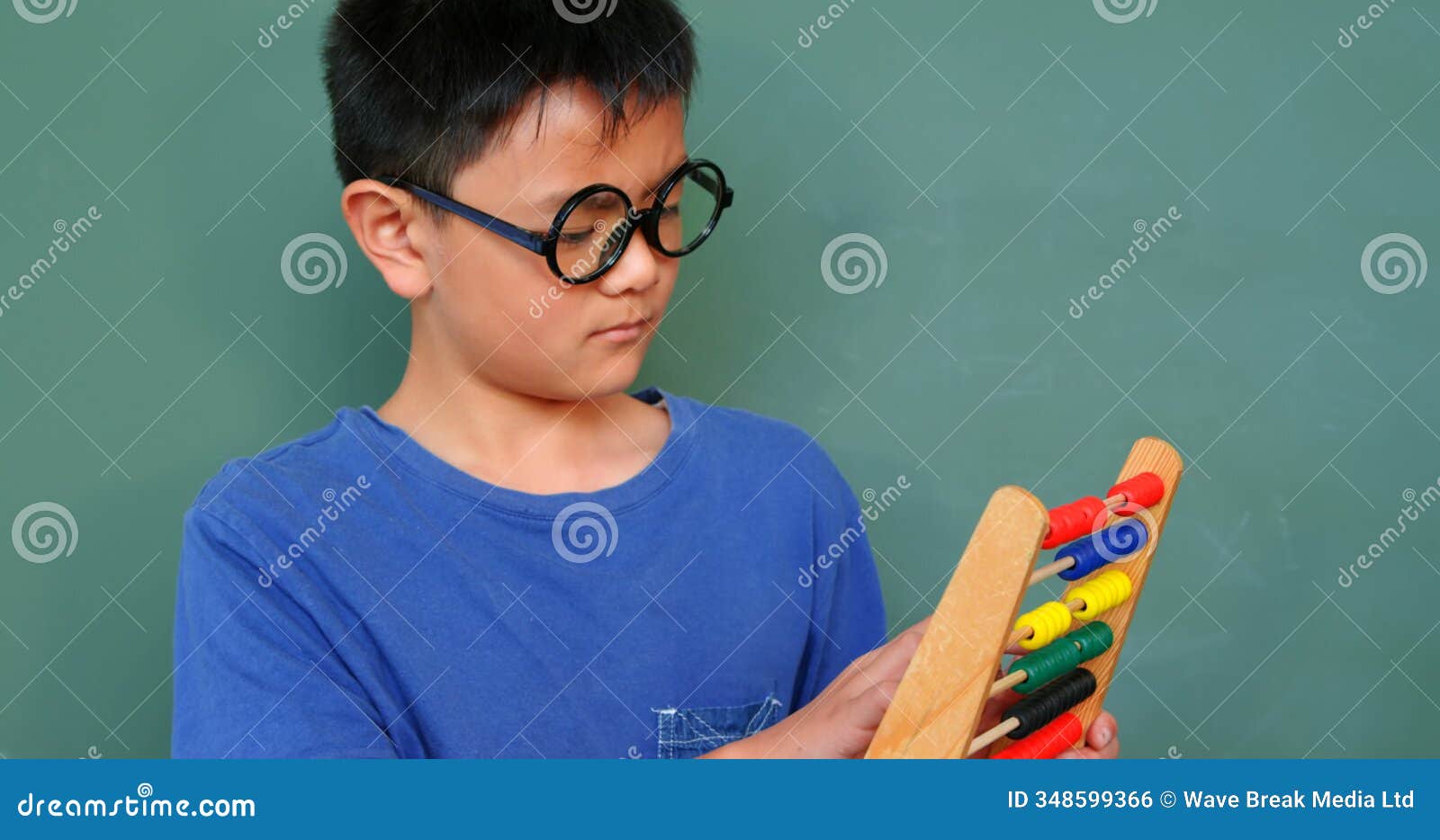Front View of Asian Schoolboy Solving Math Problem with Abacus in a ...