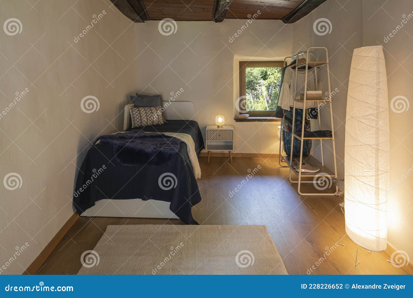 Front View Bedroom with Single Bed, Bedside Table with a Lamp Above and ...