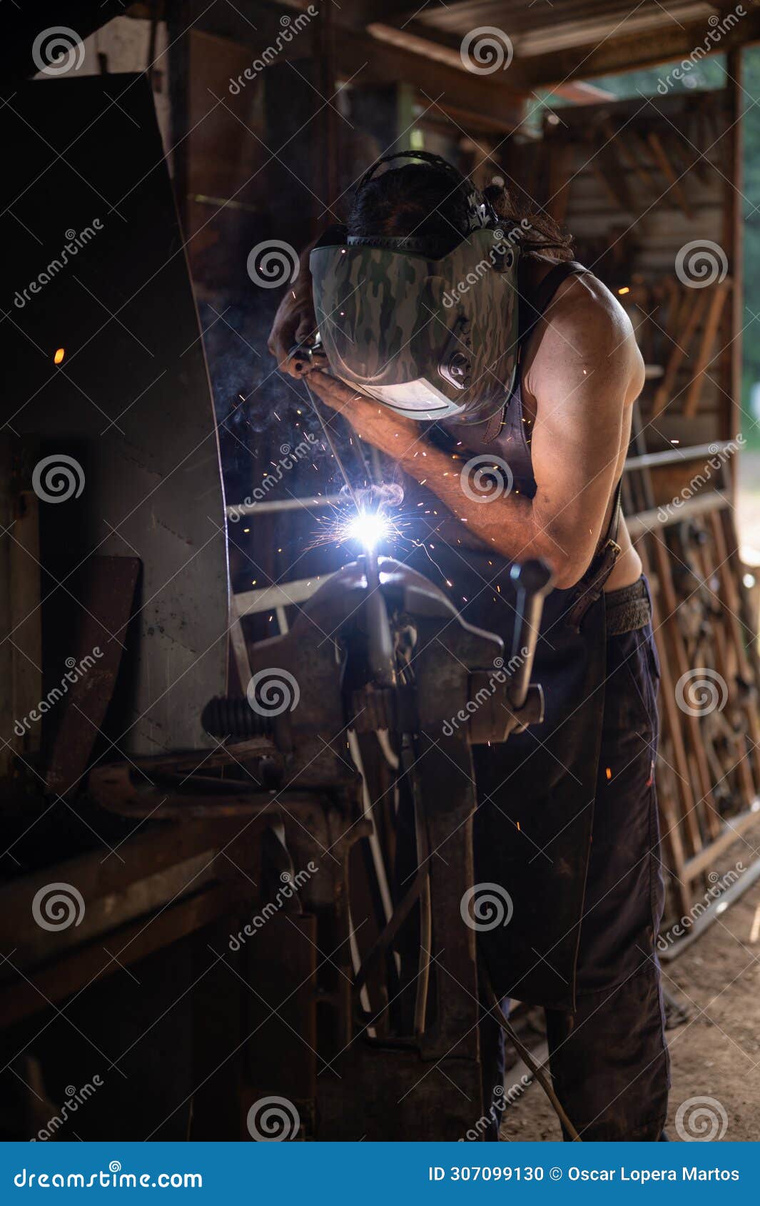 Front View of Blacksmith Welding a Piece of Iron in His Home Workshop ...
