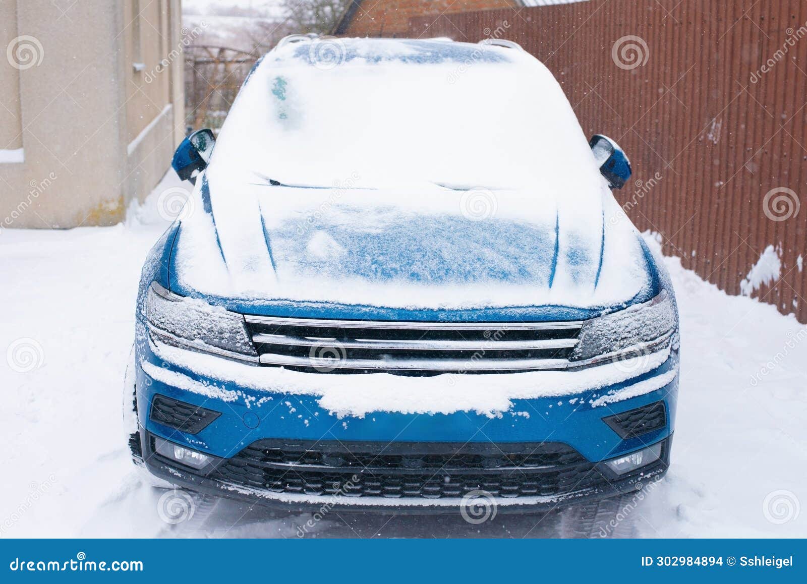 Front View Blue Modern Car Covered in Snow is Parked in the Yard Stock ...