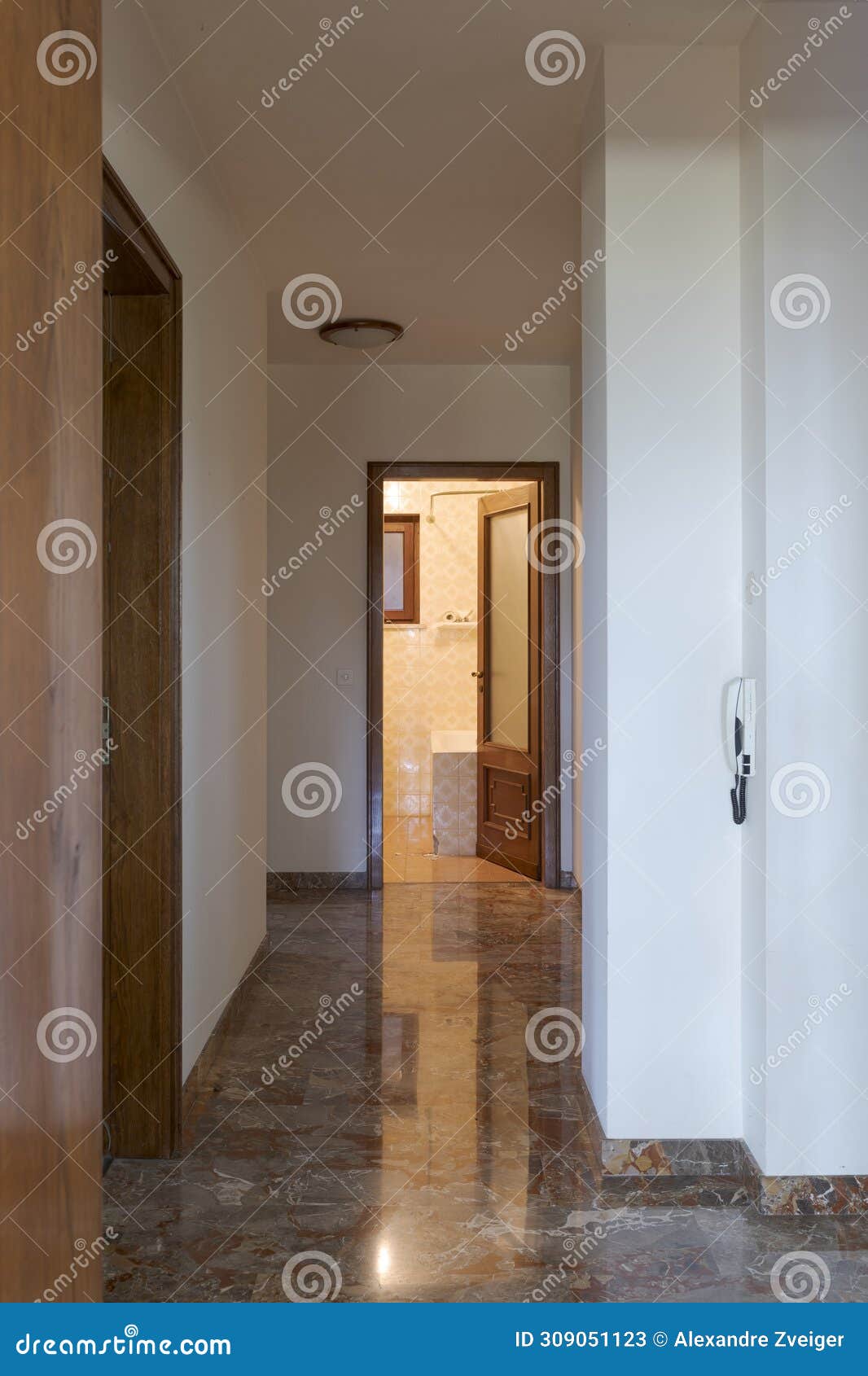 Front View Corridor with an Open Door To the Bathroom at the End ...