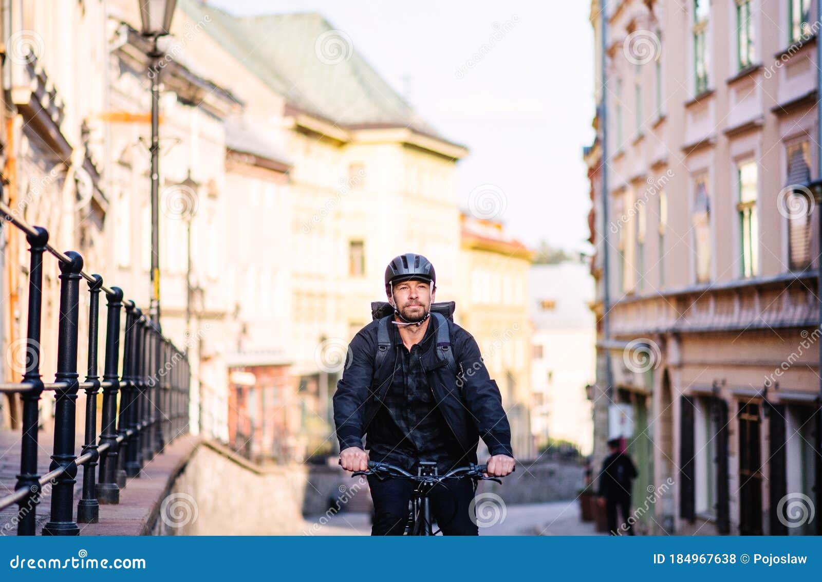 Front View of Delivery Man Courier with Bicycle Cycling in Town. Stock ...