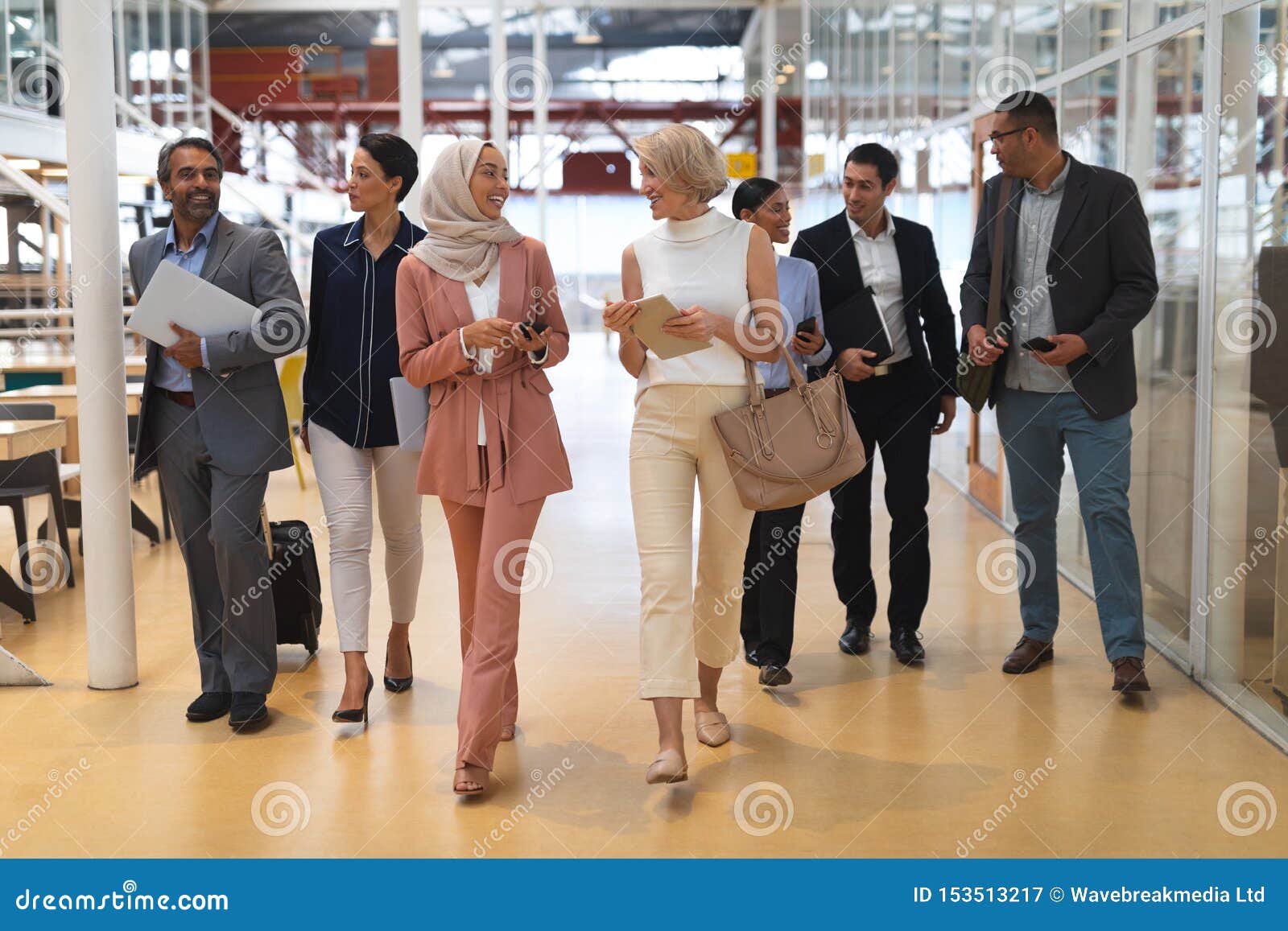 Business People Interacting with Each Other while Walking in a Modern ... Business People Interacting with Each Other while Walking in a Modern ...