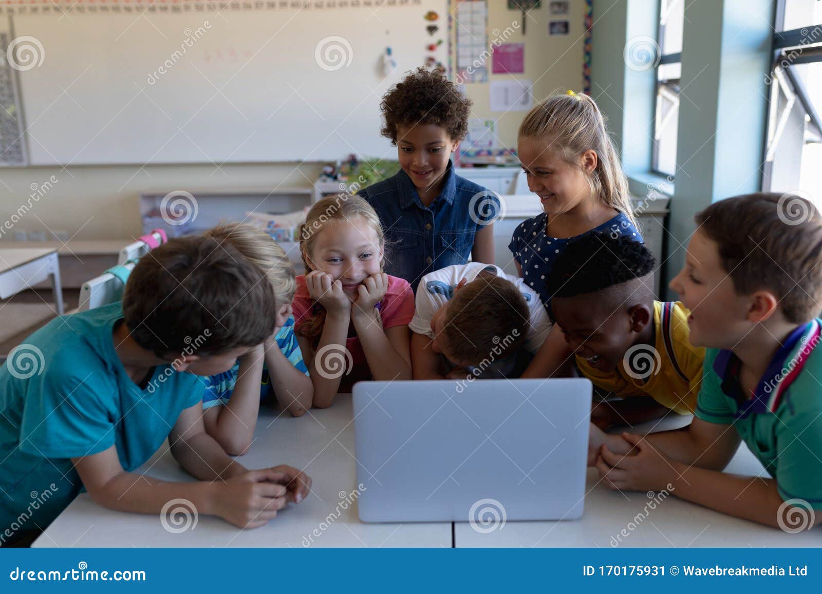 Group of Schoolchildren Using a Laptop Computer in an Elementary School ...
