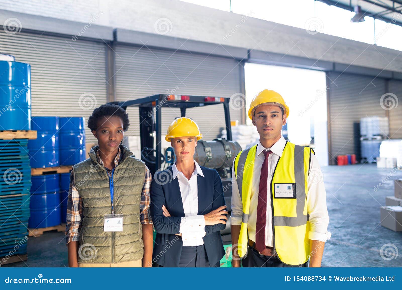 Warehouse Staff Looking at Camera in Warehouse Stock Photo - Image of ...