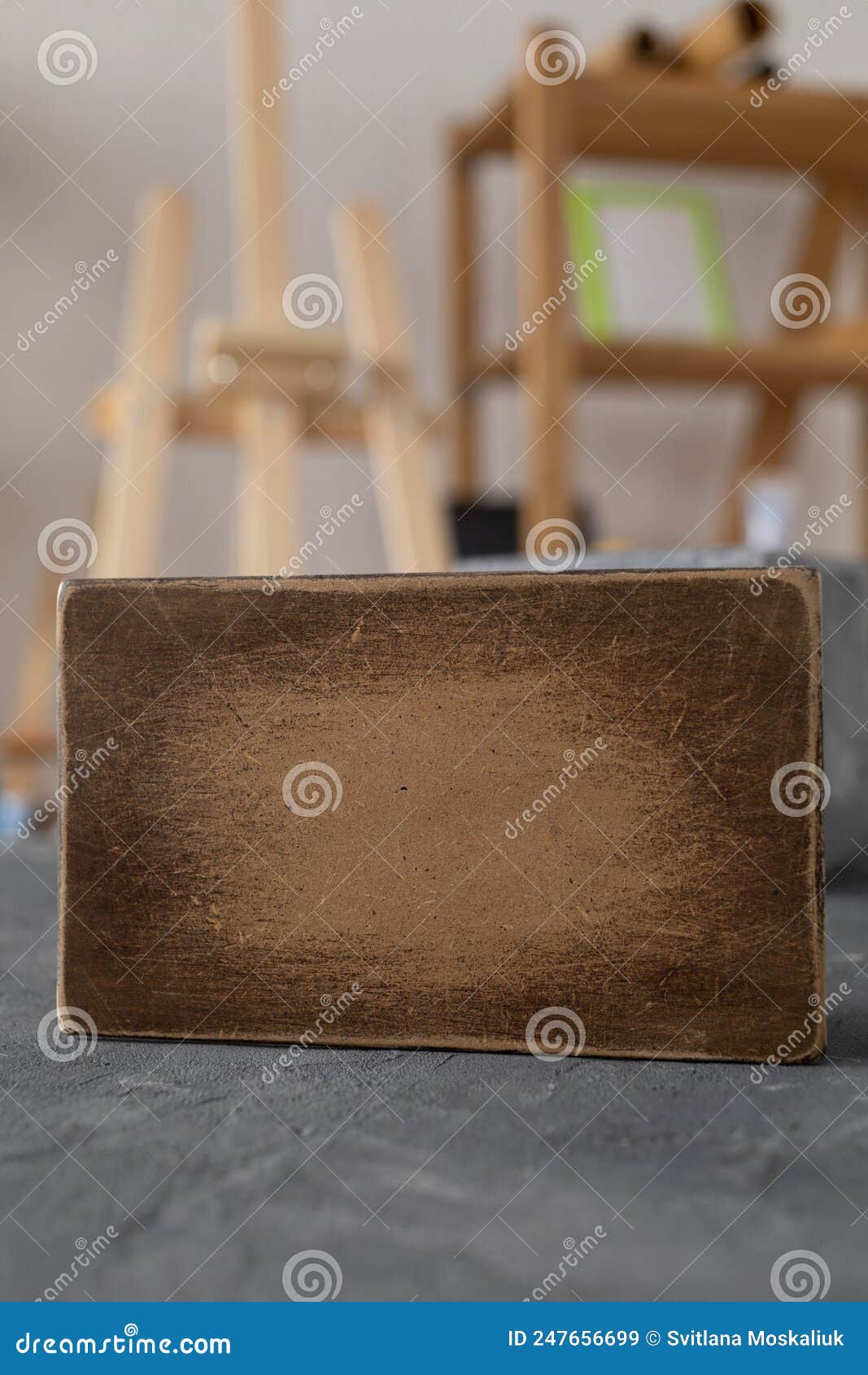 Front View of Empty Nameplate at Table and Artist Tools. Paintbrush and ...