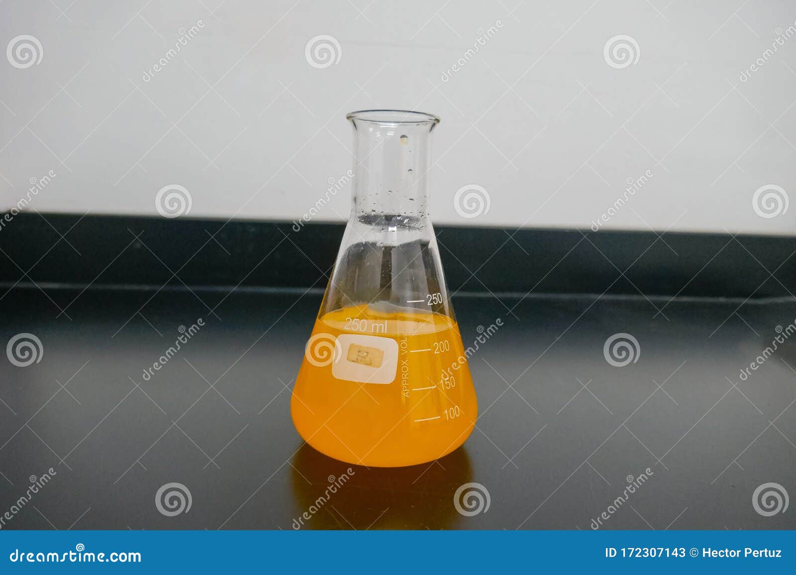 Front View of Erlenmeyer with Orange Chemical Solution and White ...